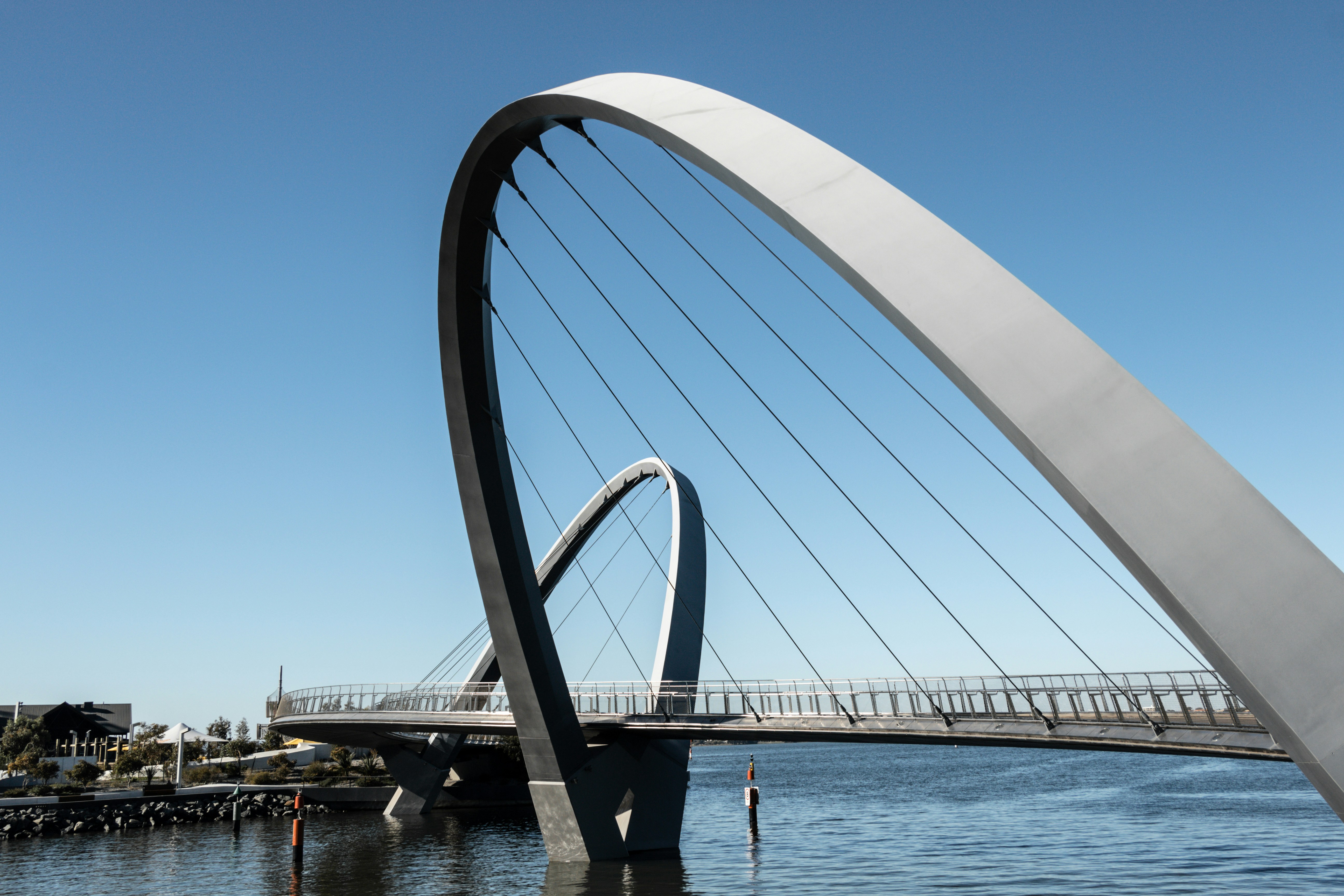 Arching Steel Weave Over Quiet Waters