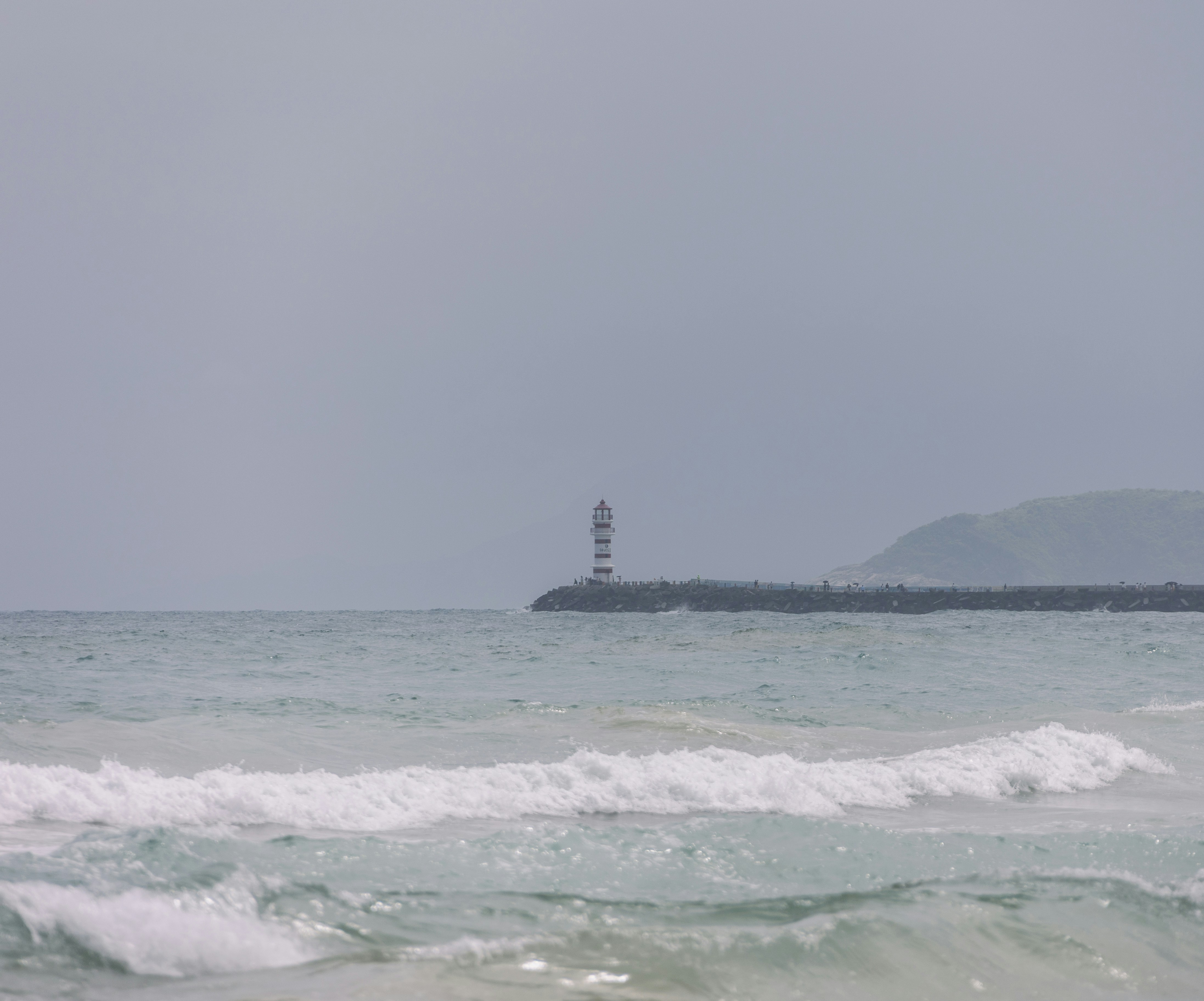 Lighthouse Quietly Standing at the Breakwater's Edge