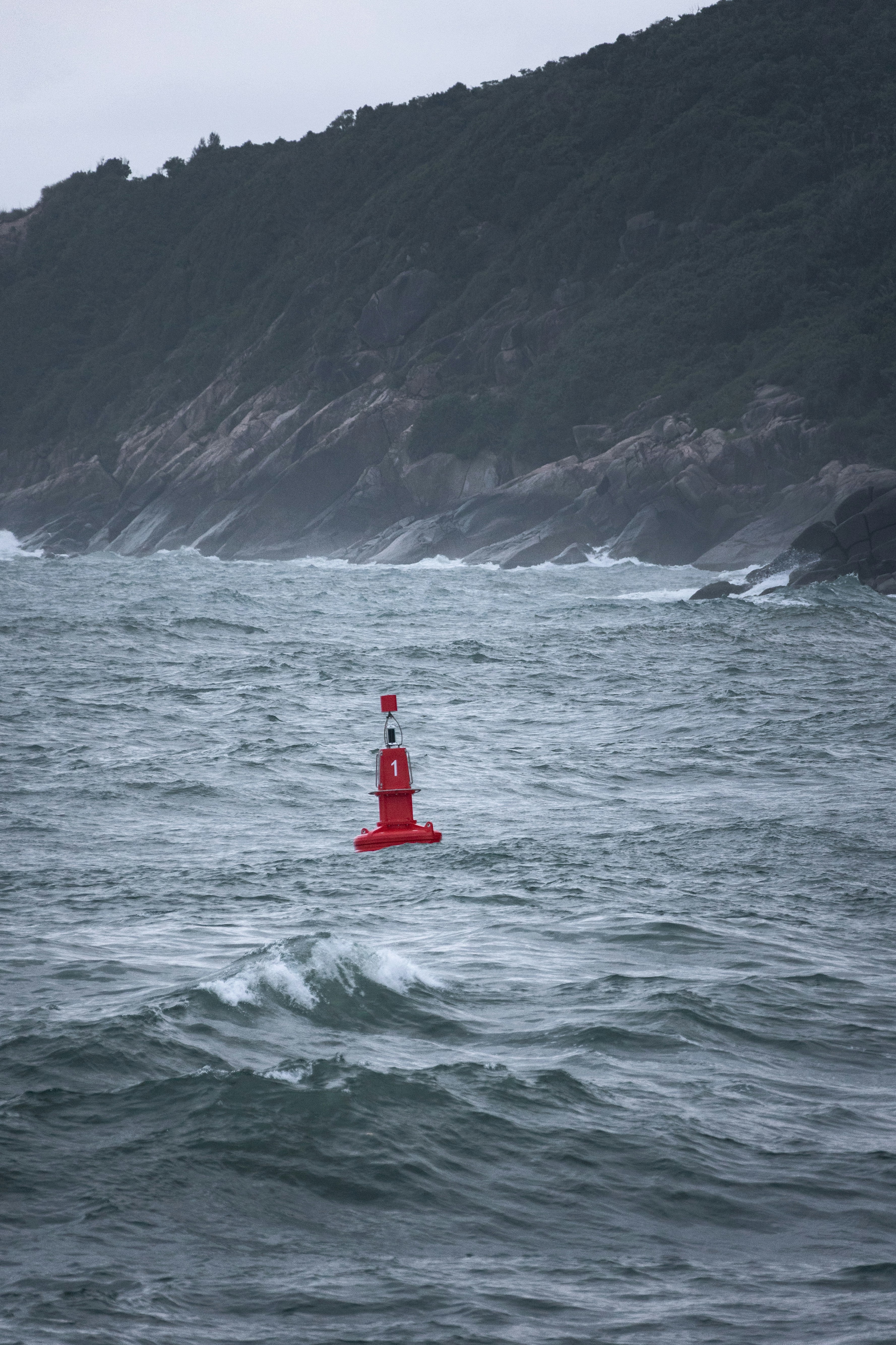 Red Buoy Amid Rough Coastal Currents