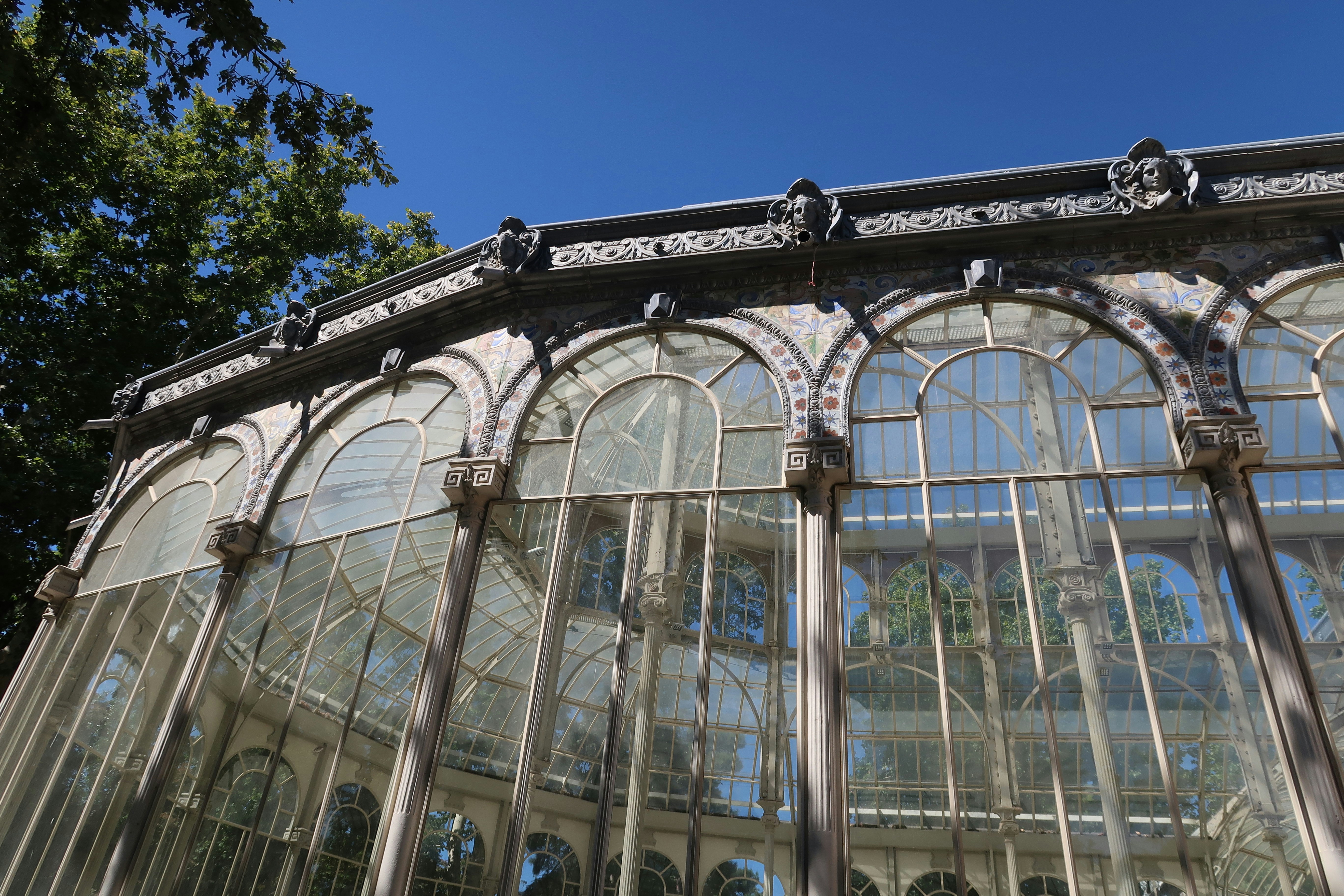 Glassed Conservatory Facade Under Sunlit Archways