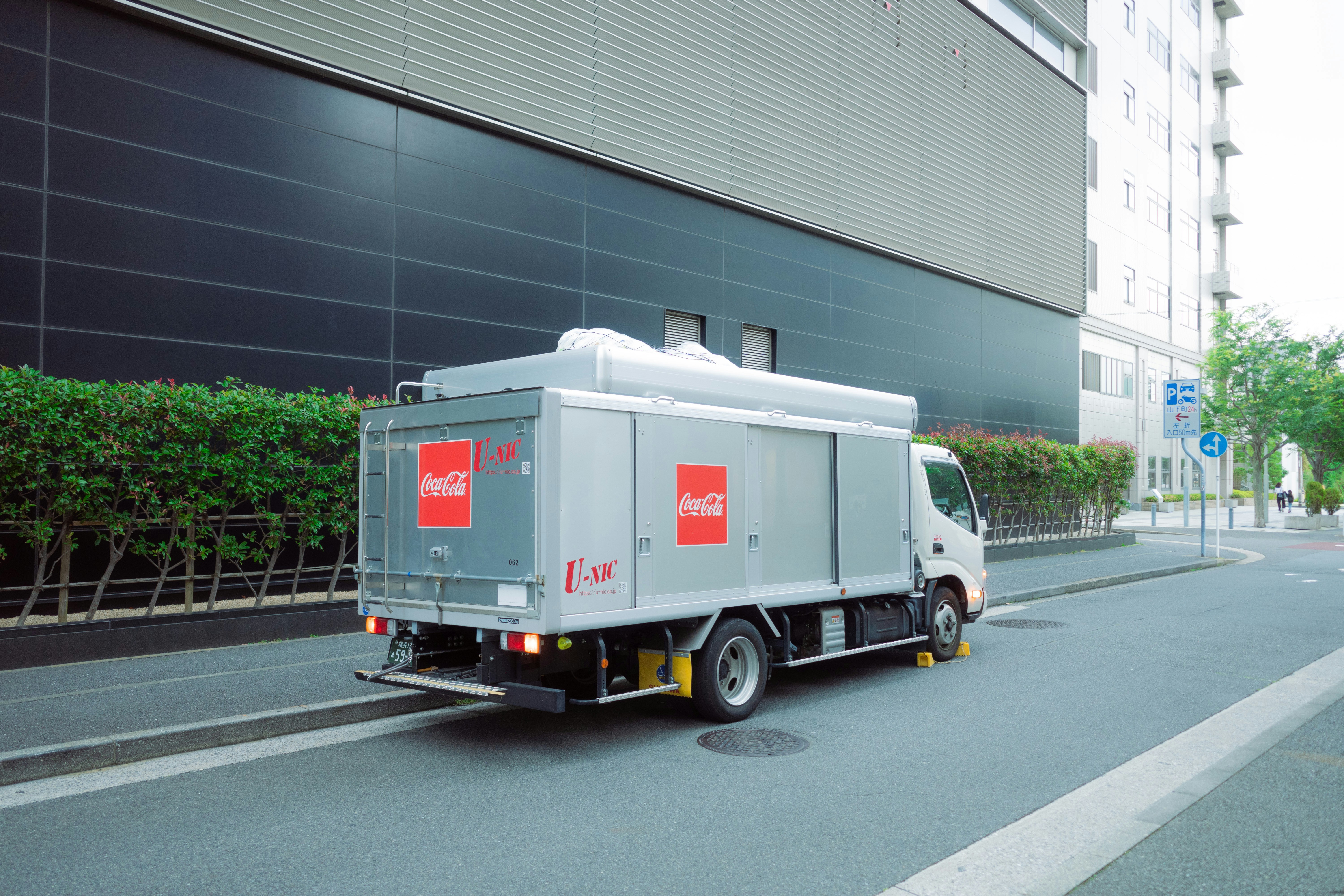 Coca-Cola Roadwork: A Street-Side Delivery Truck Poised by a Modern Urban Wall