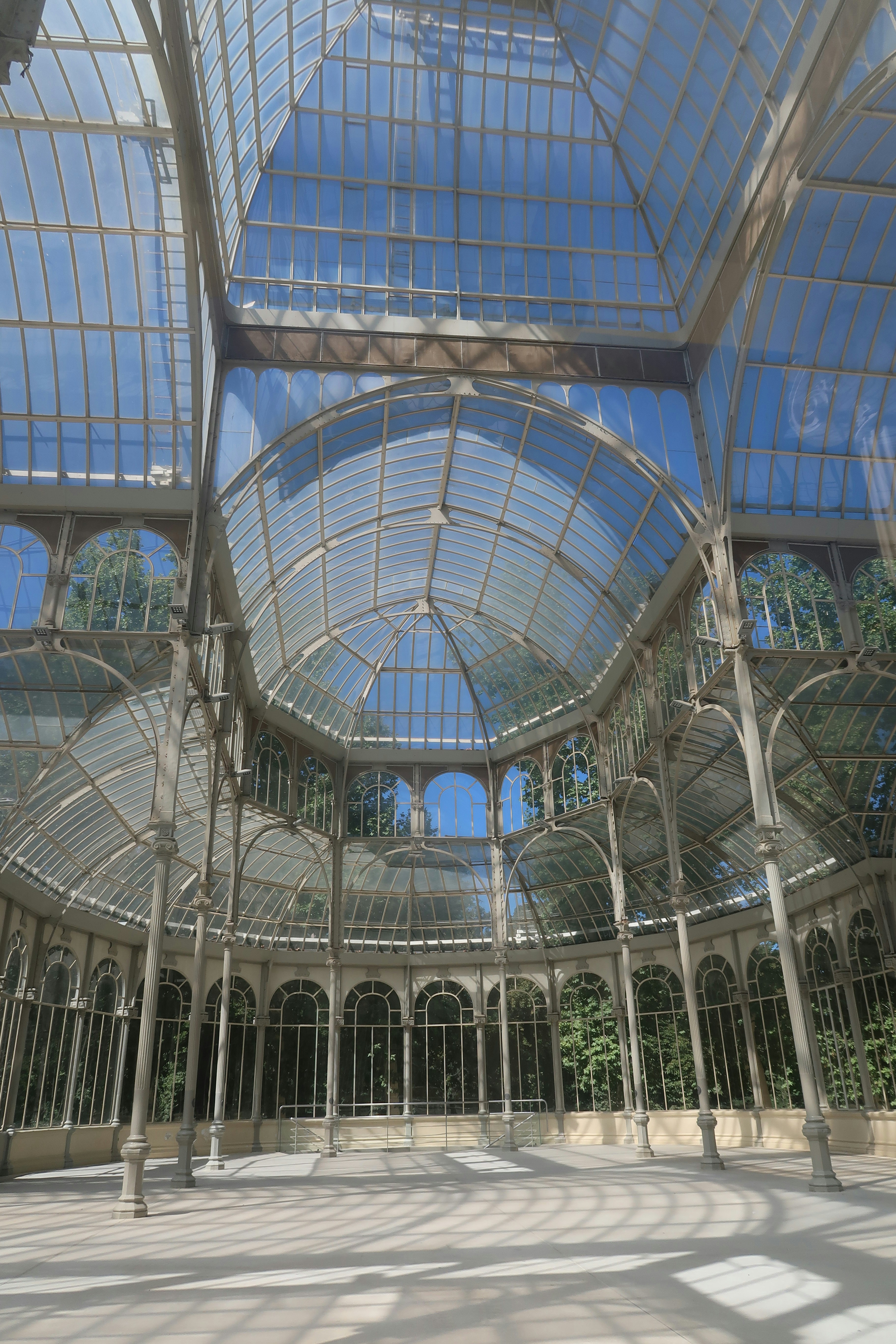 Symmetrical Glass Cathedral: Sunlit Conservatory Portrait