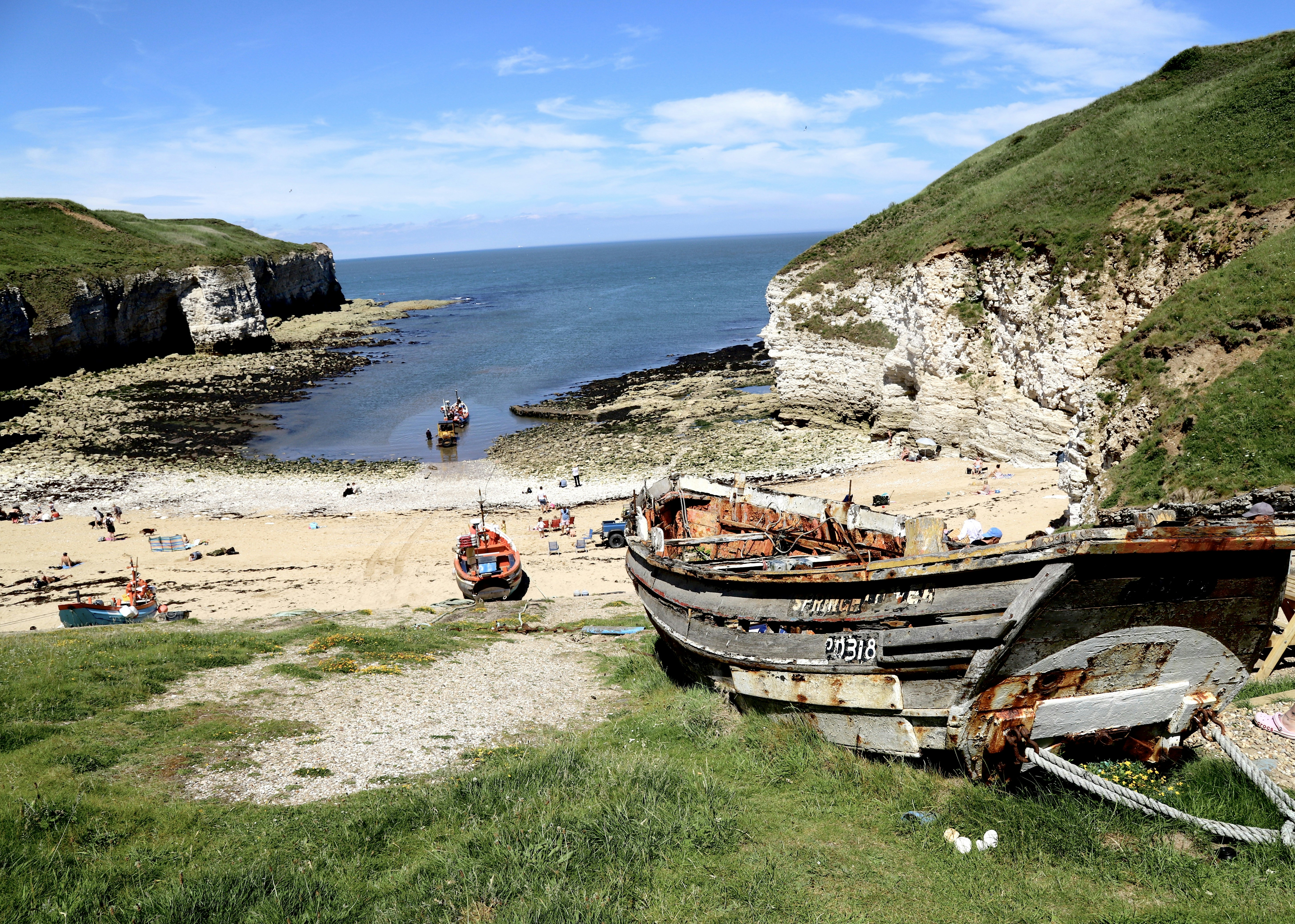 Bleached Hulls at the Cove: A Weathered Shipyard by Cliffside Beach