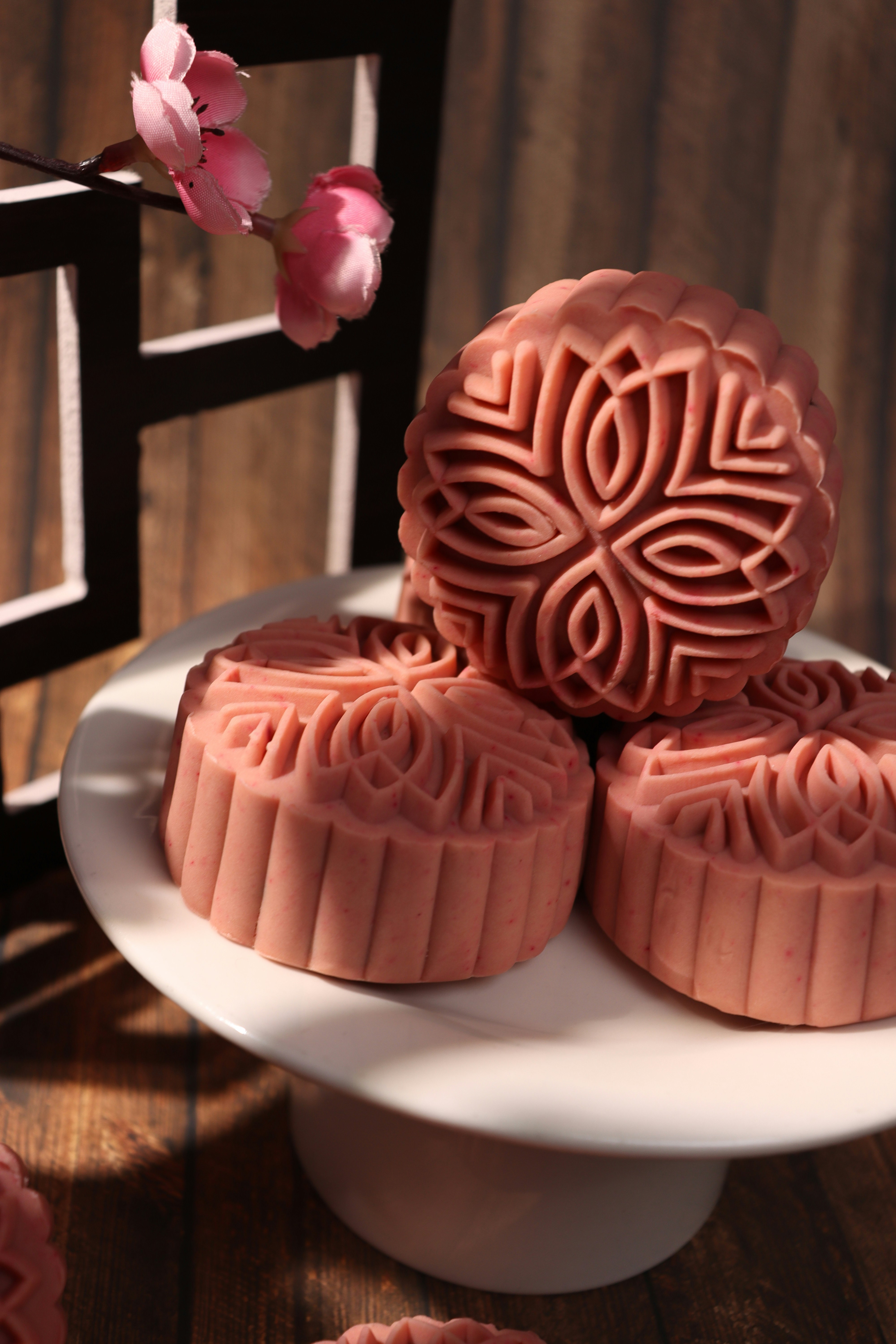 Softly Carved Pink Delights on a Dark Wood Stage