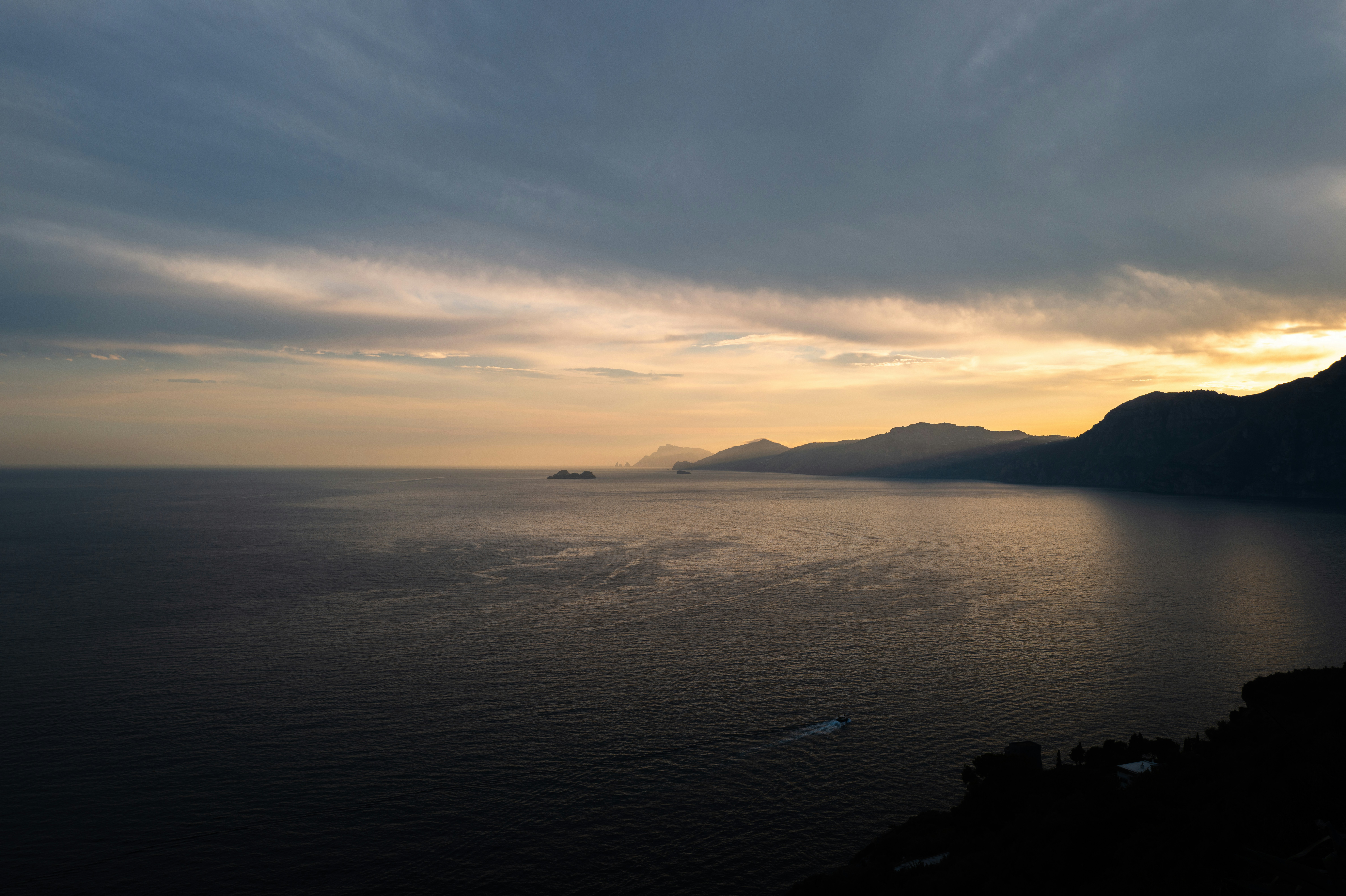 Dusk on the Caldera: Quiet Sea Below a Winding Ridge