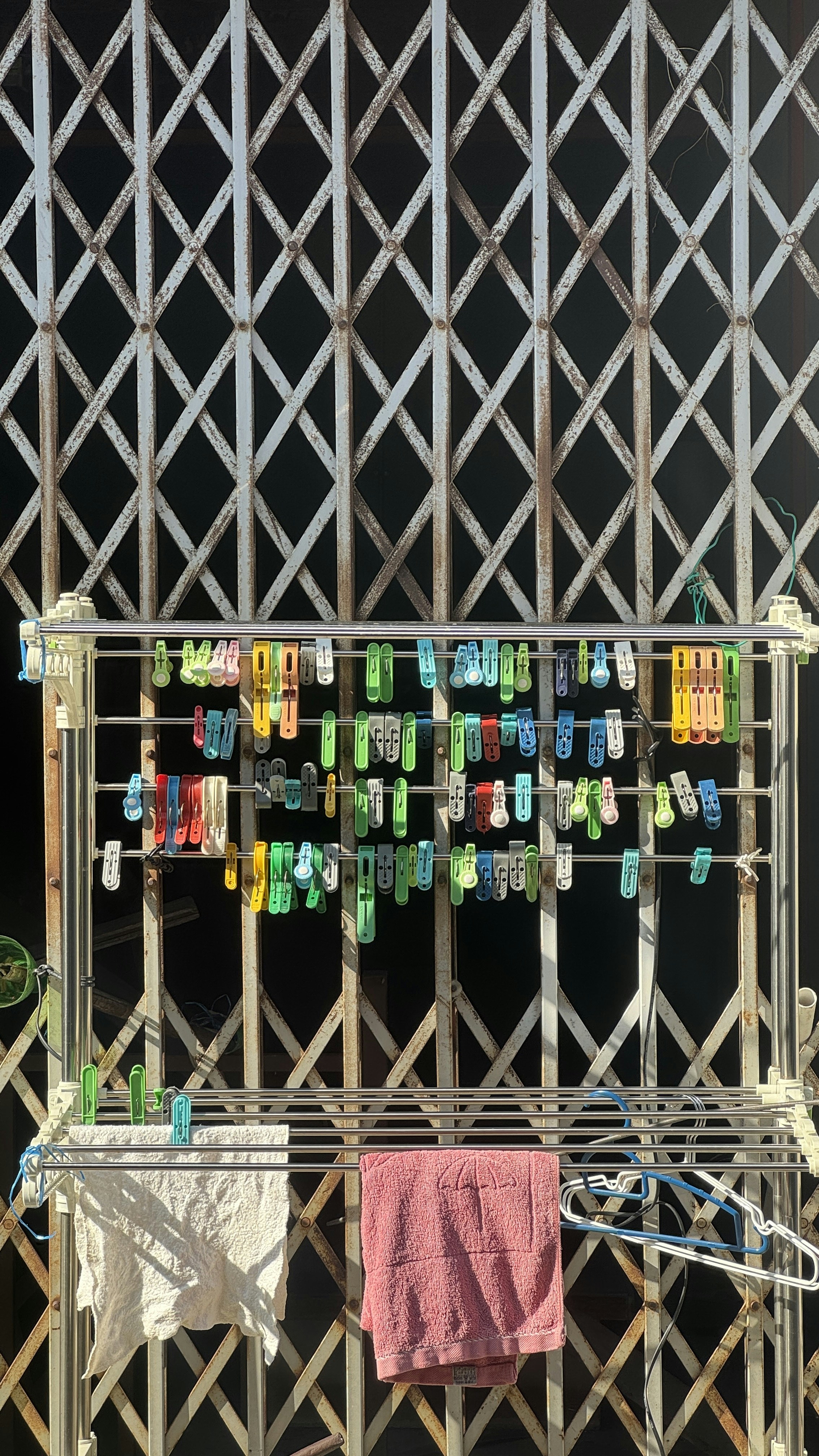 Colorful Clothesline in Front of Iron Gate