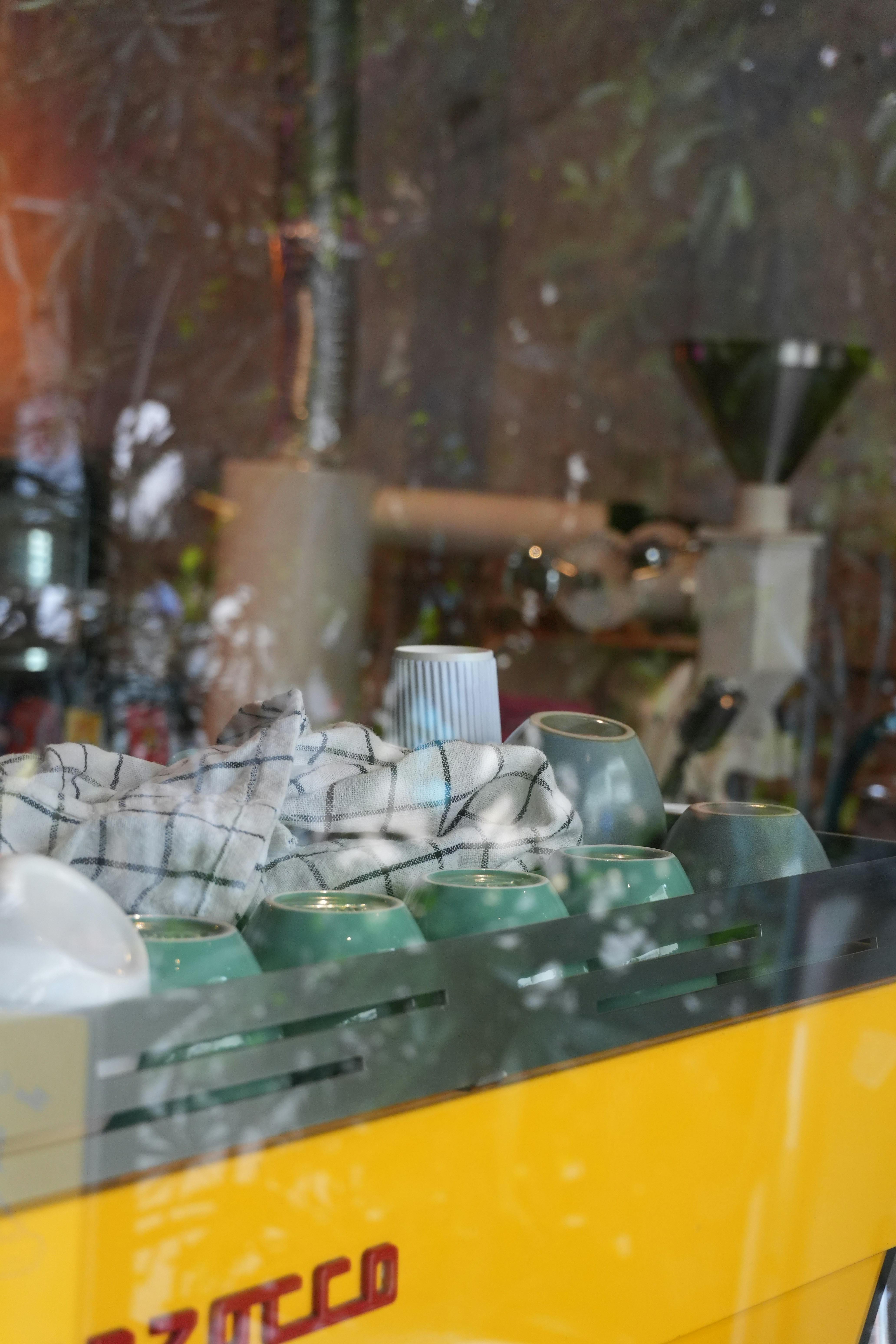 Ceramic Cups in a Shop Display Through Glass