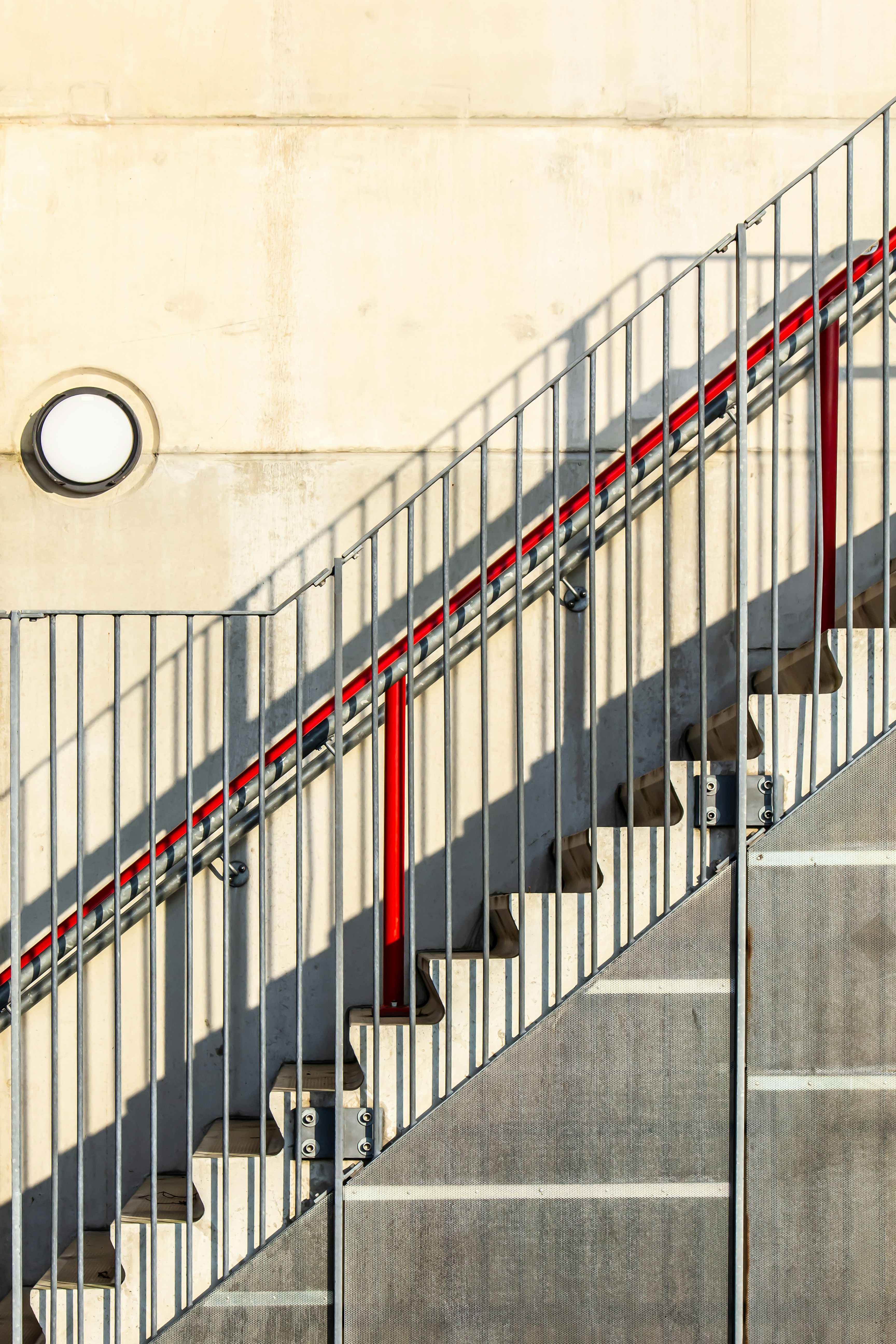 Red Rail and Shadowed Staircase Geometry