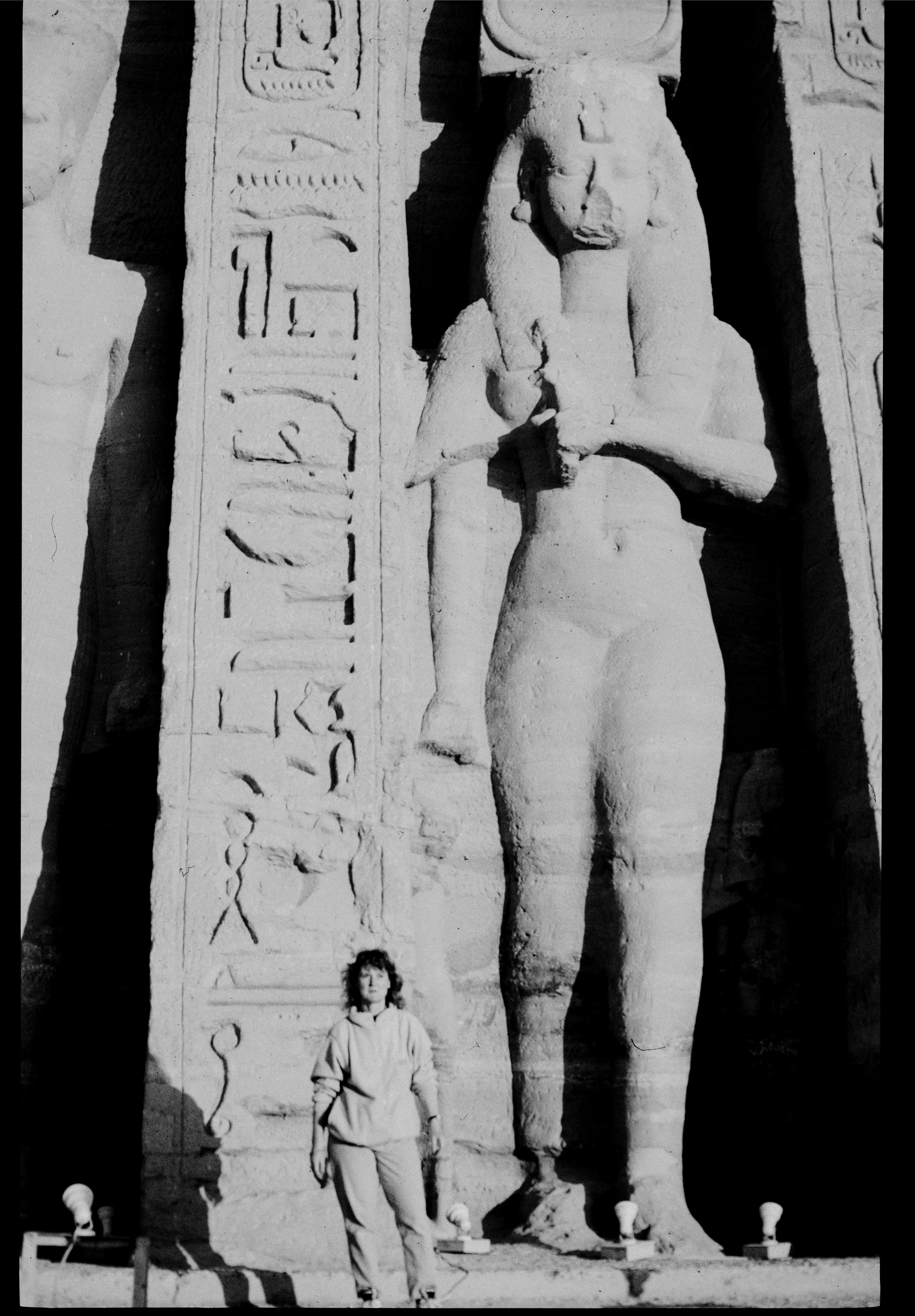 Giant Figure, Small Witness: A Human Among Ancient Carvings