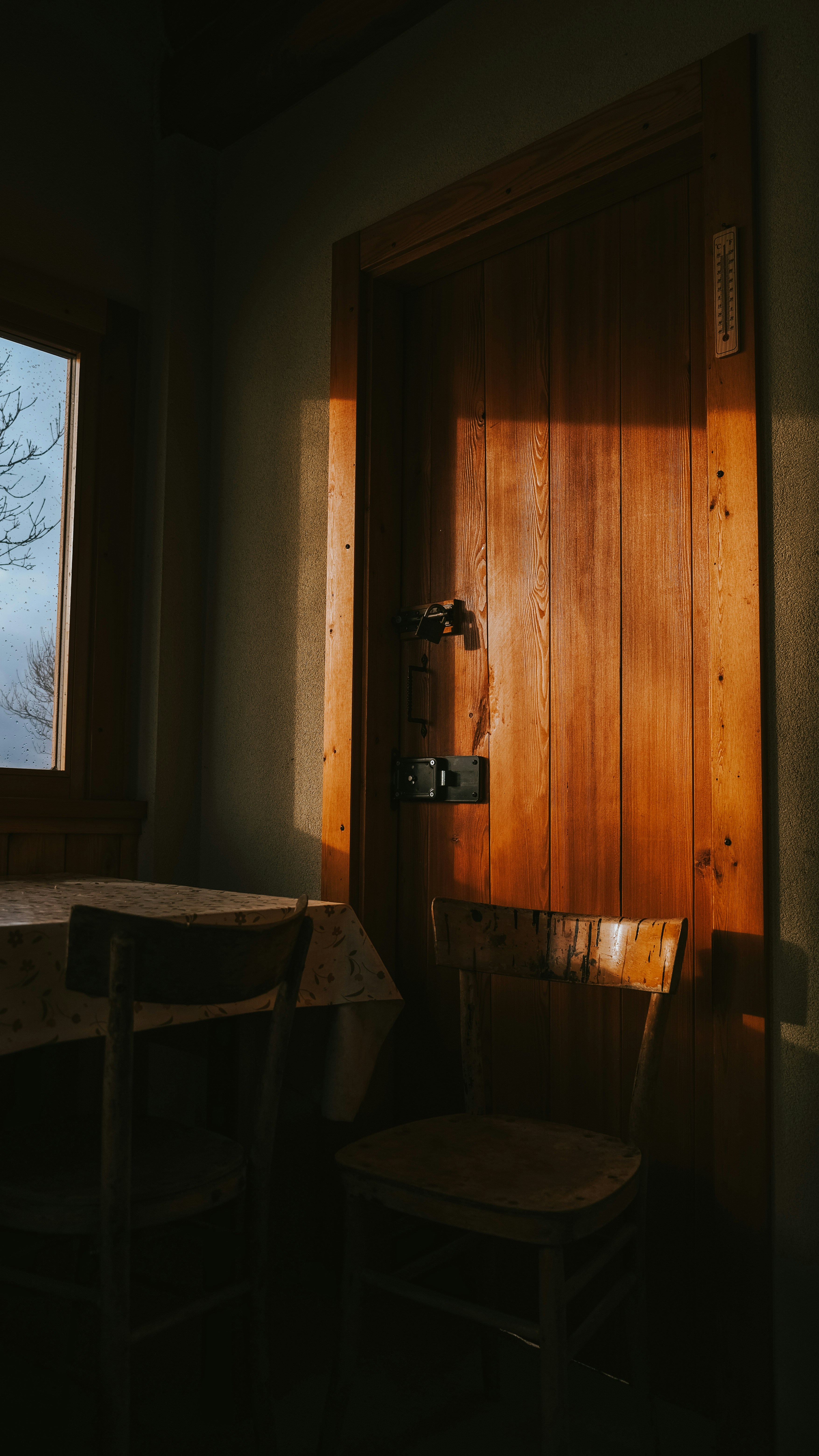 Sunlit Doorway: Warmth Cutting Through a Dim Kitchen