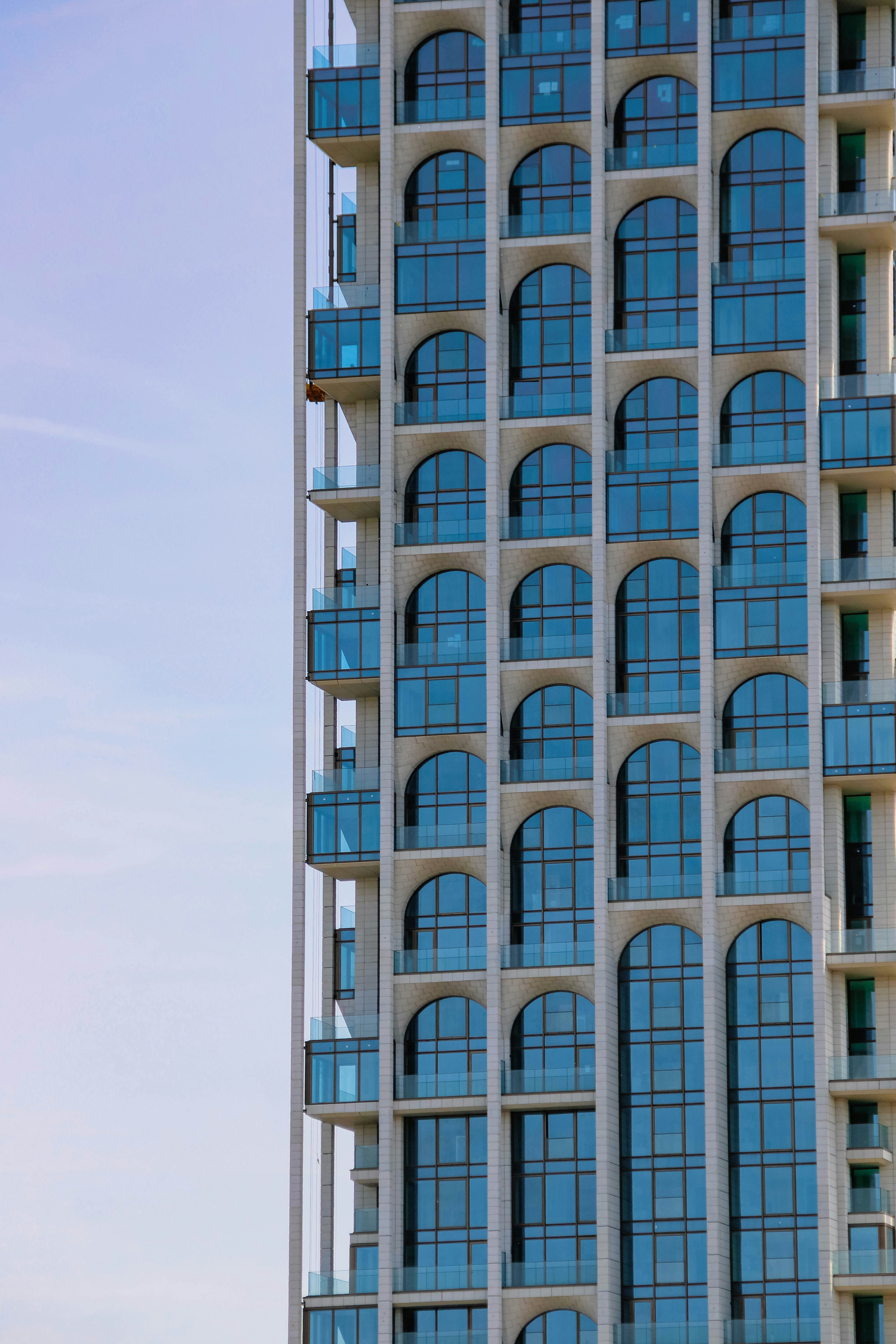 Grid of Arched Windows: A Skyscraper’s Repetition and Light