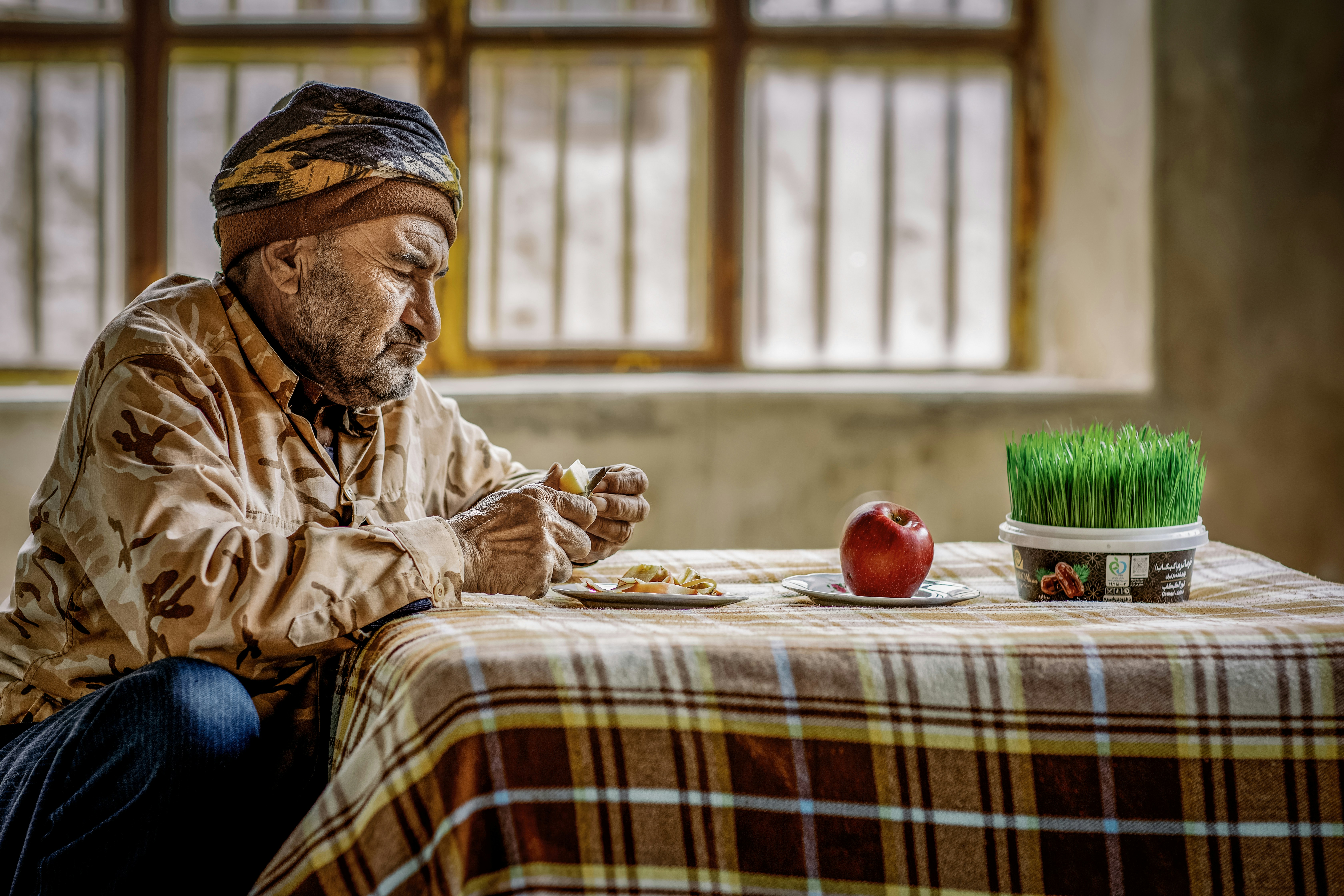 The Quiet Breakfast: A Weathered Handsman with a Tiny Meal