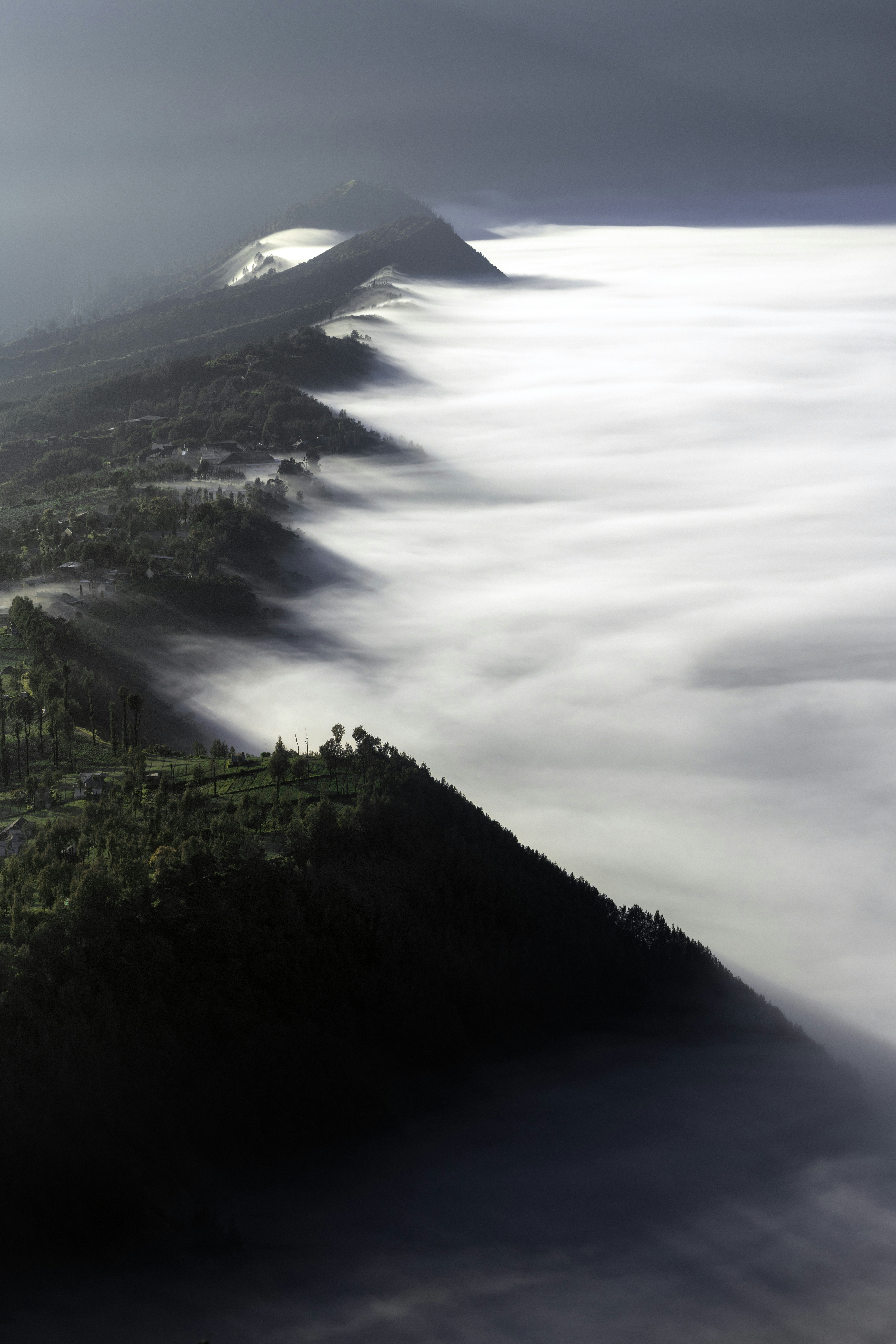 Clouds Unfurl Along the Ridge: A Mountain Crest Pierced by Mist