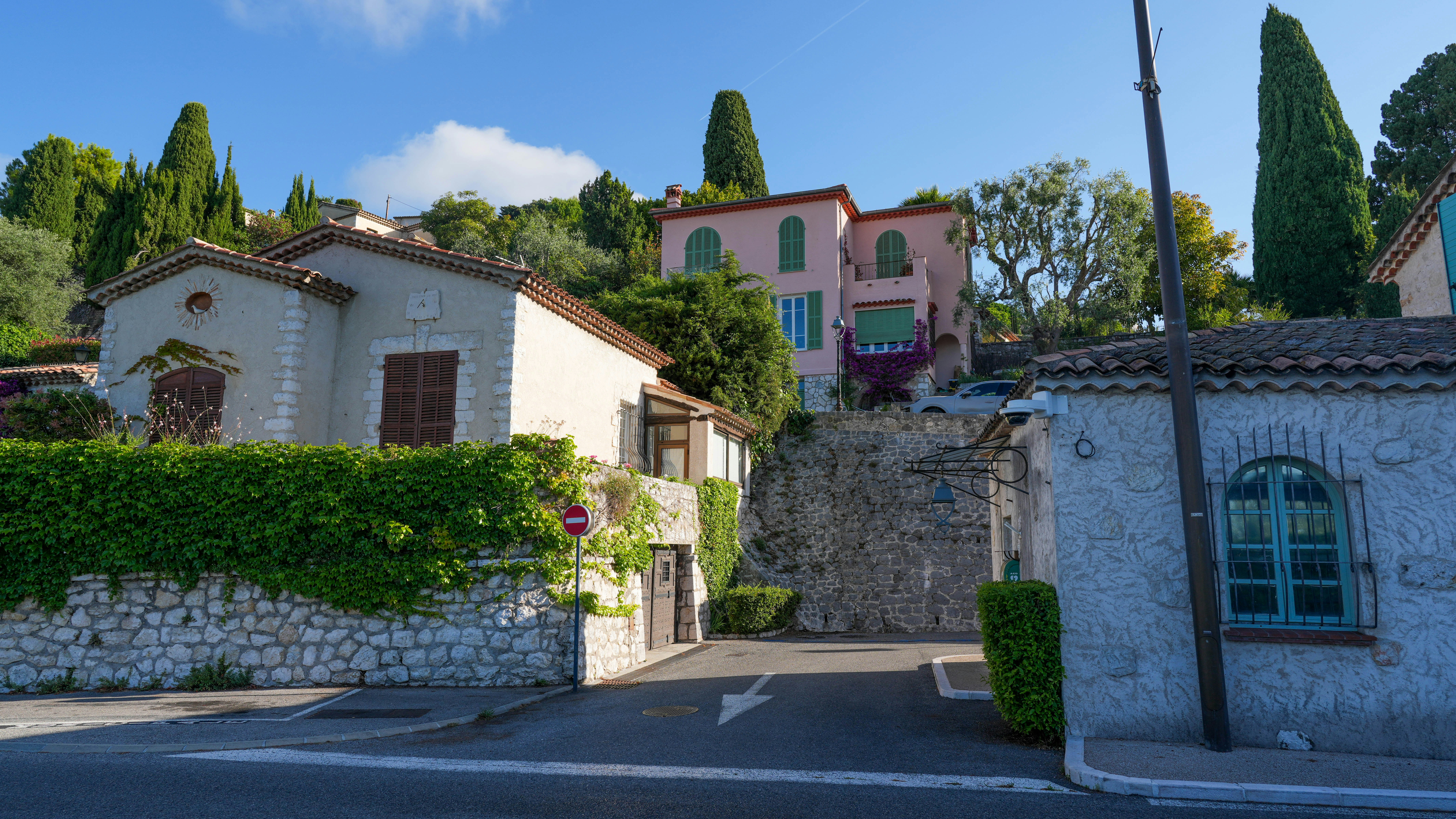 Hillside Village Arches and Stucco Homes Under a Bright Sky