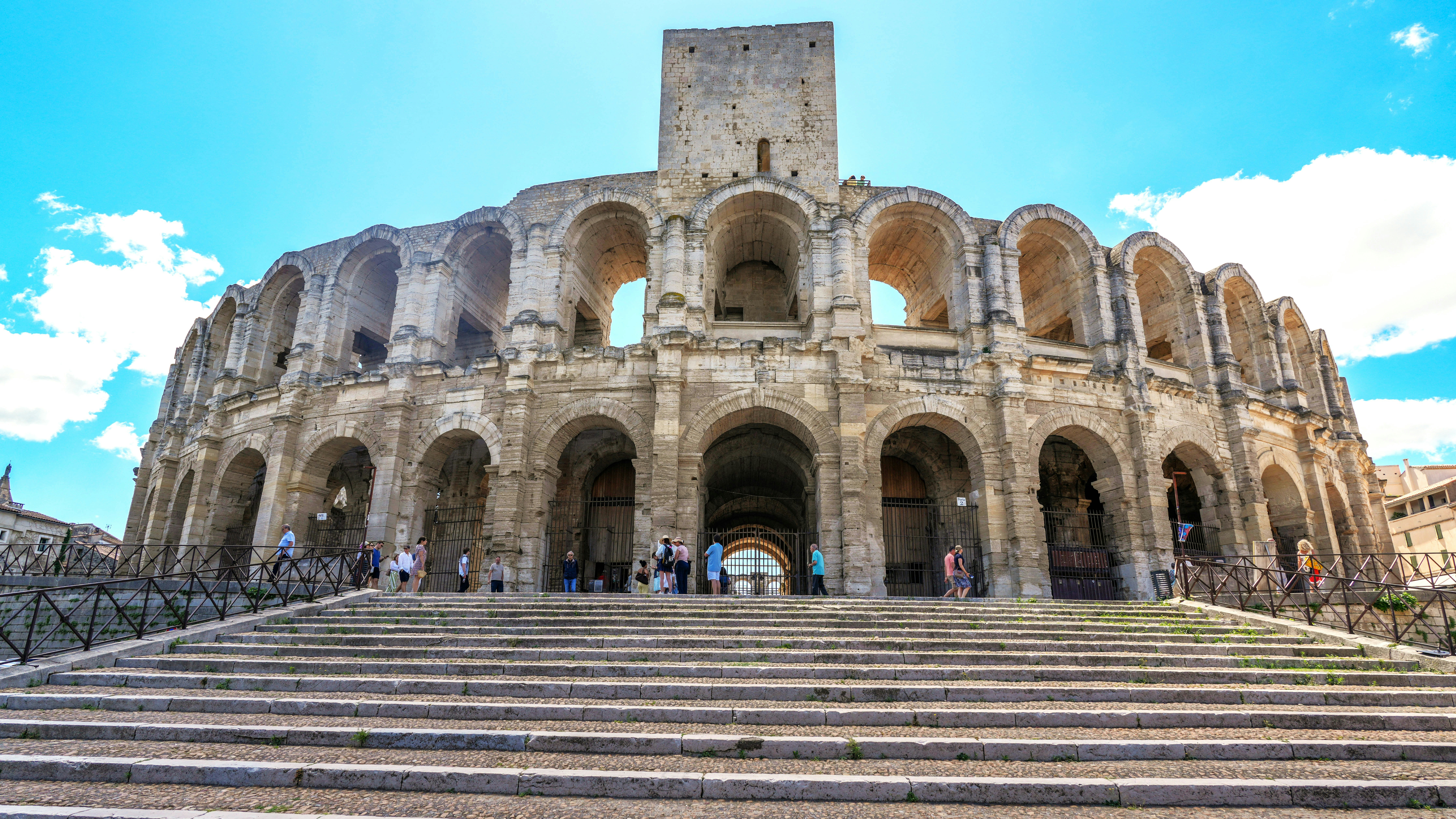 Steps to the Arena: A Sunlit Roman Ruin Framed by Sky