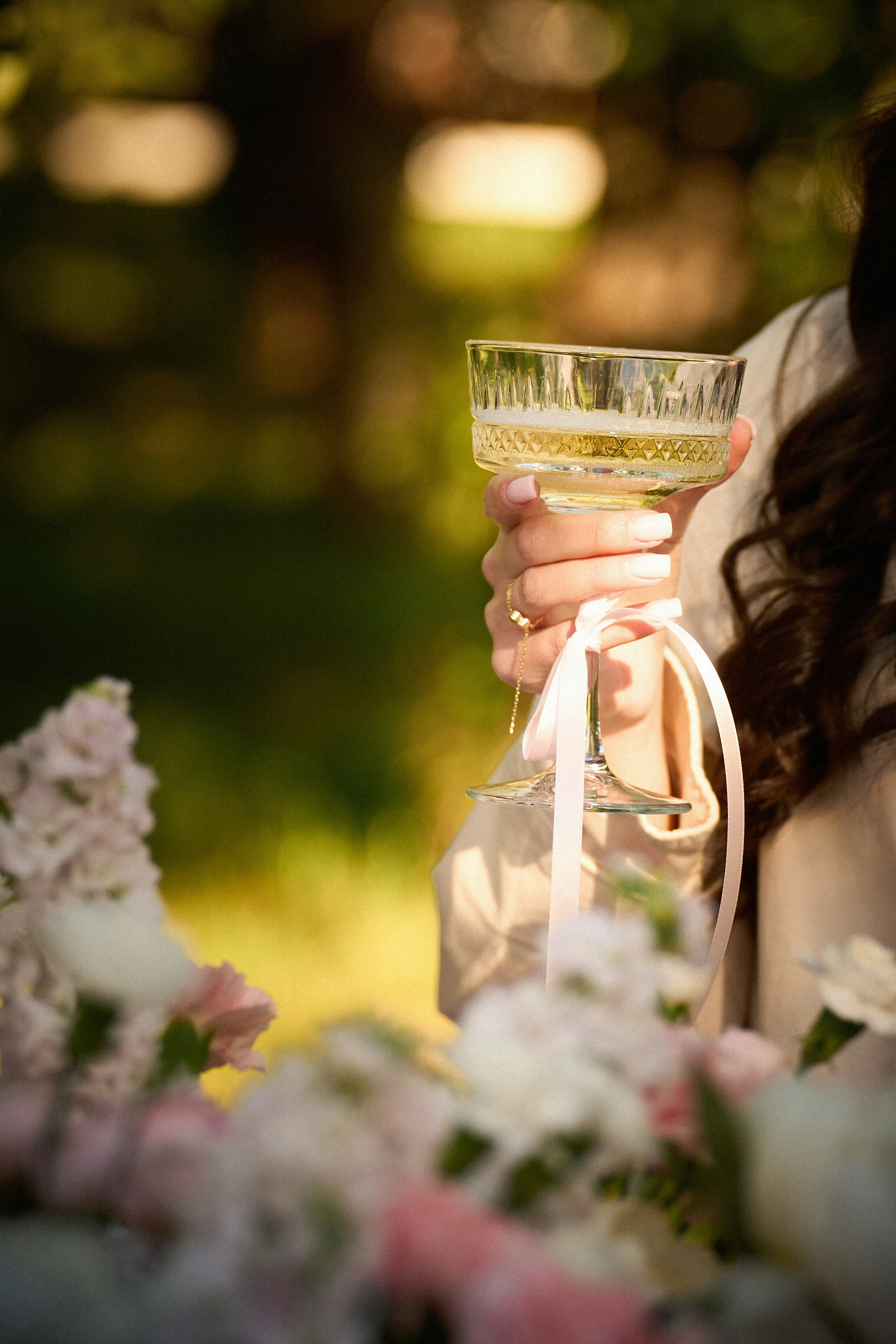 A Quiet Toast: Crystal Glass and Soft Garden Light