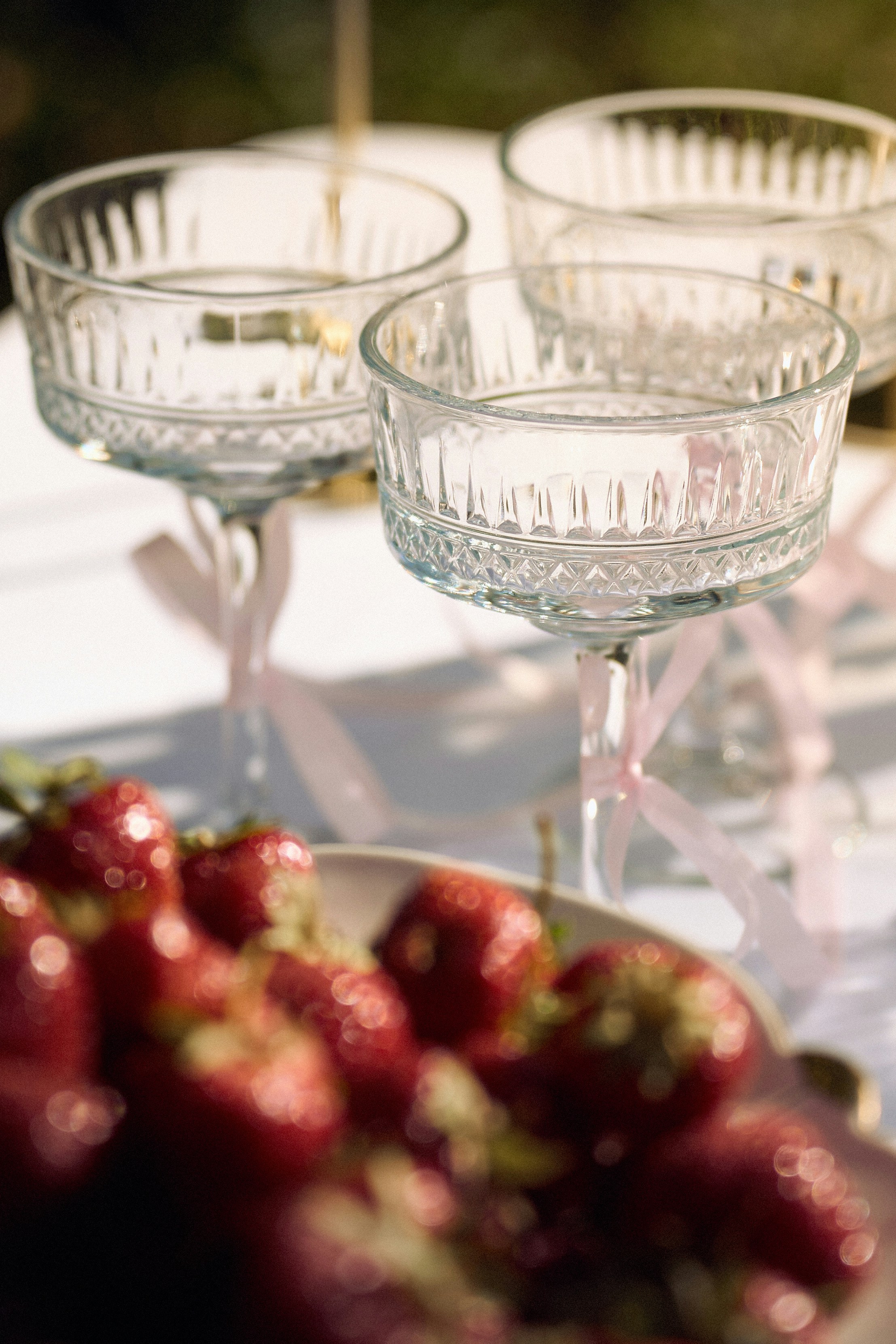 Crystal Glasses and Strawberry Bowl: a Sunlit Table Moment