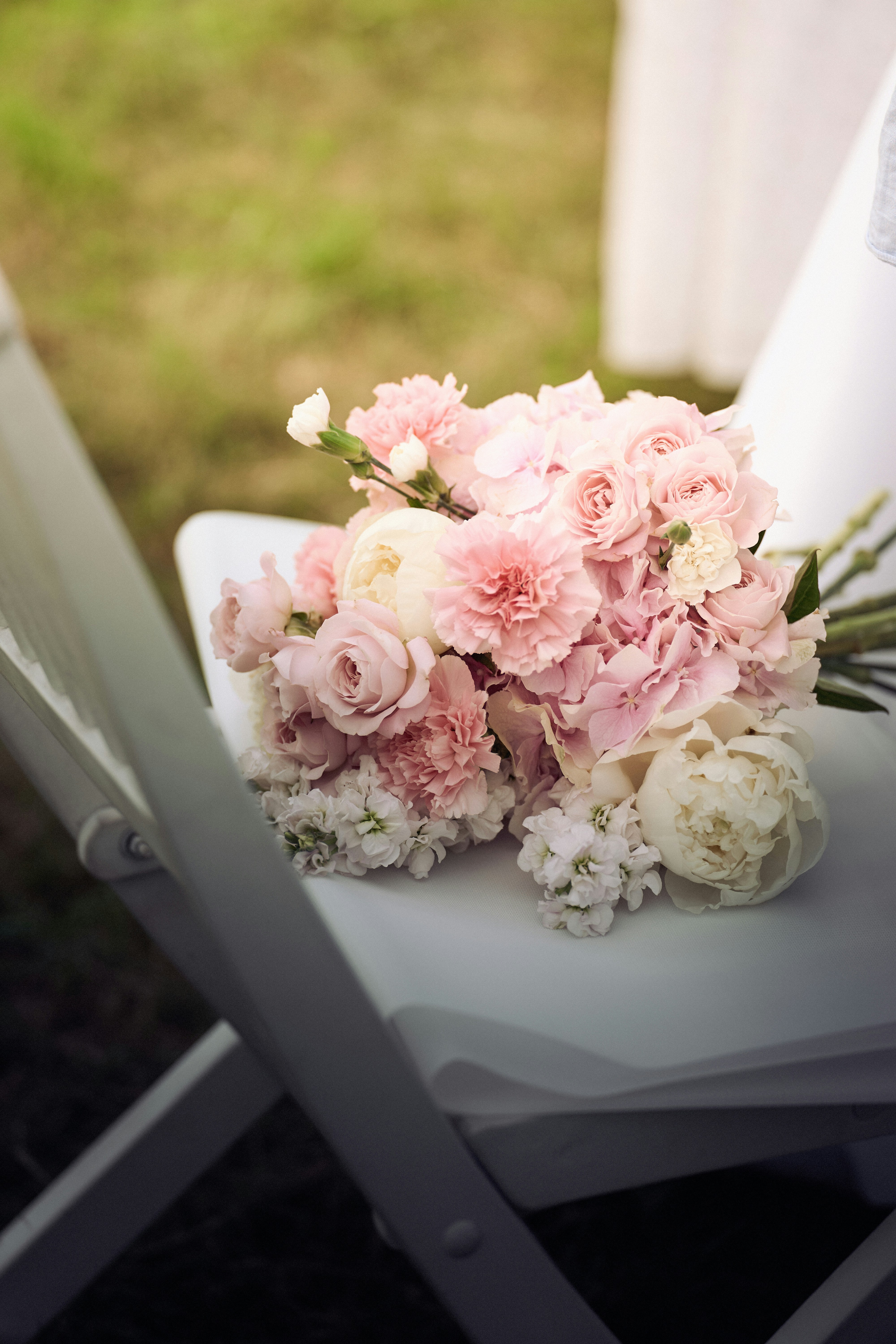 Pastel Bouquet Resting on a White Chair