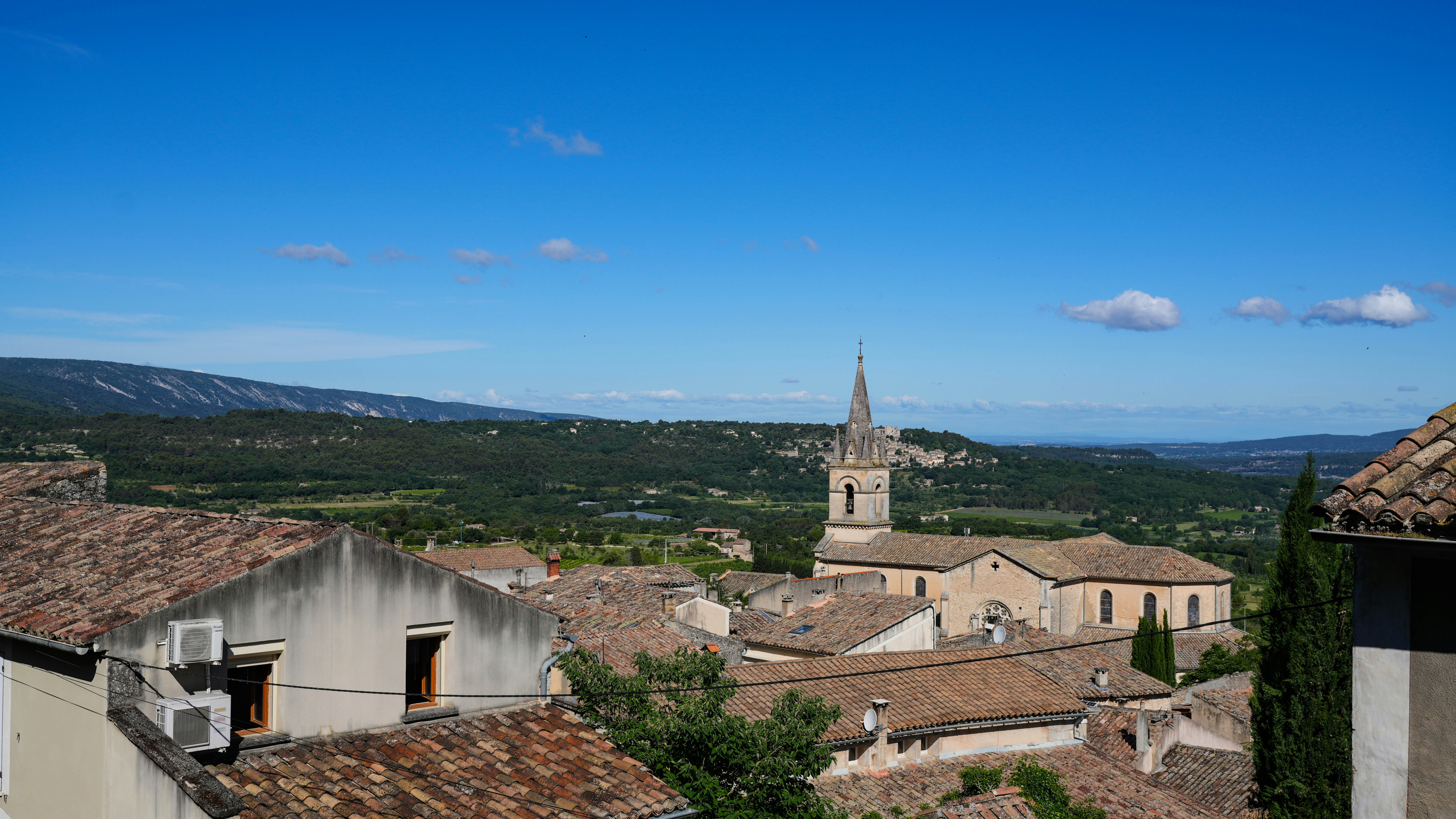 Rooftop Village Above a Distant Valleyscape with a Bell Tower