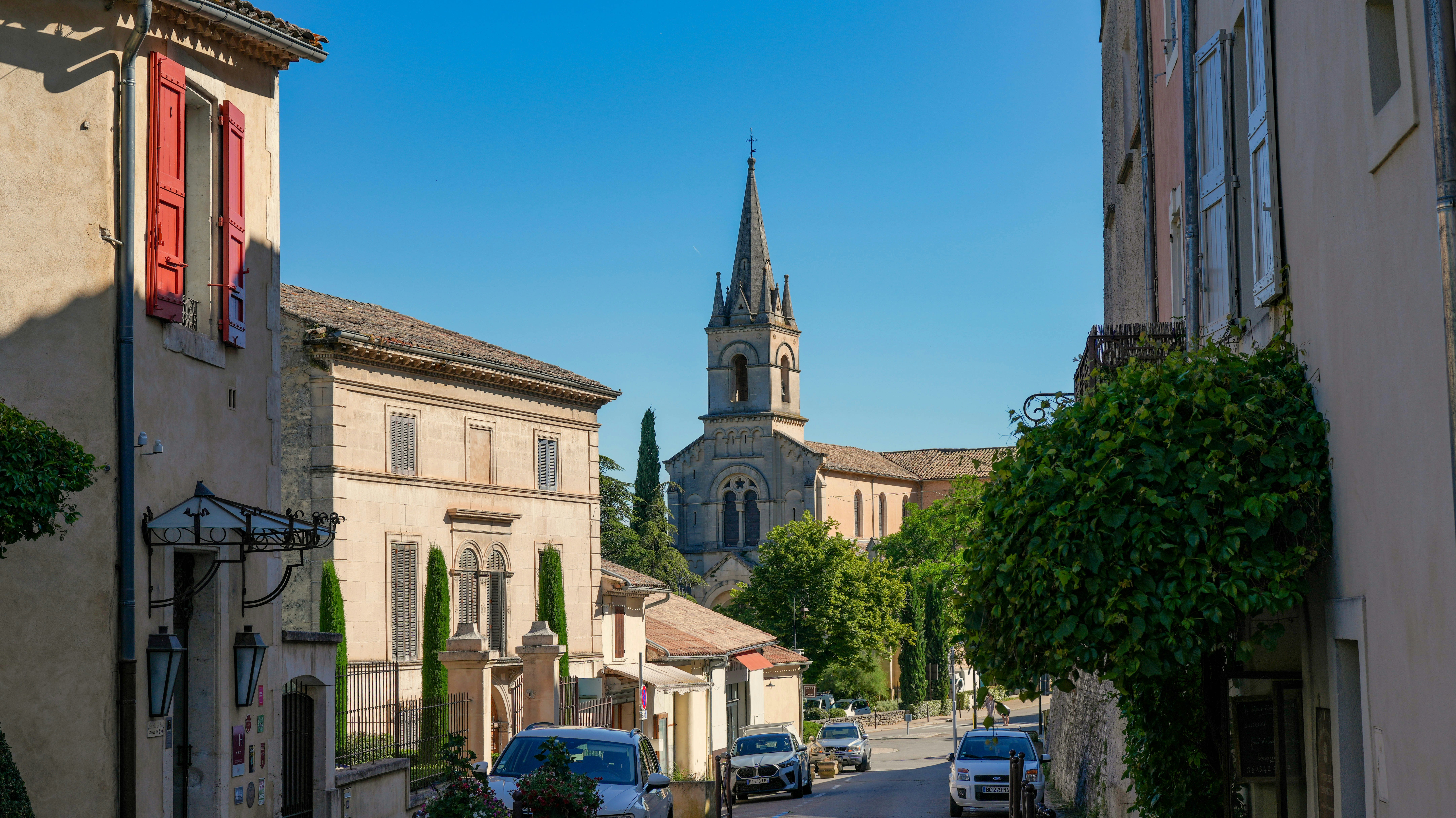 Sunlit Rue Toward the Bell Tower
