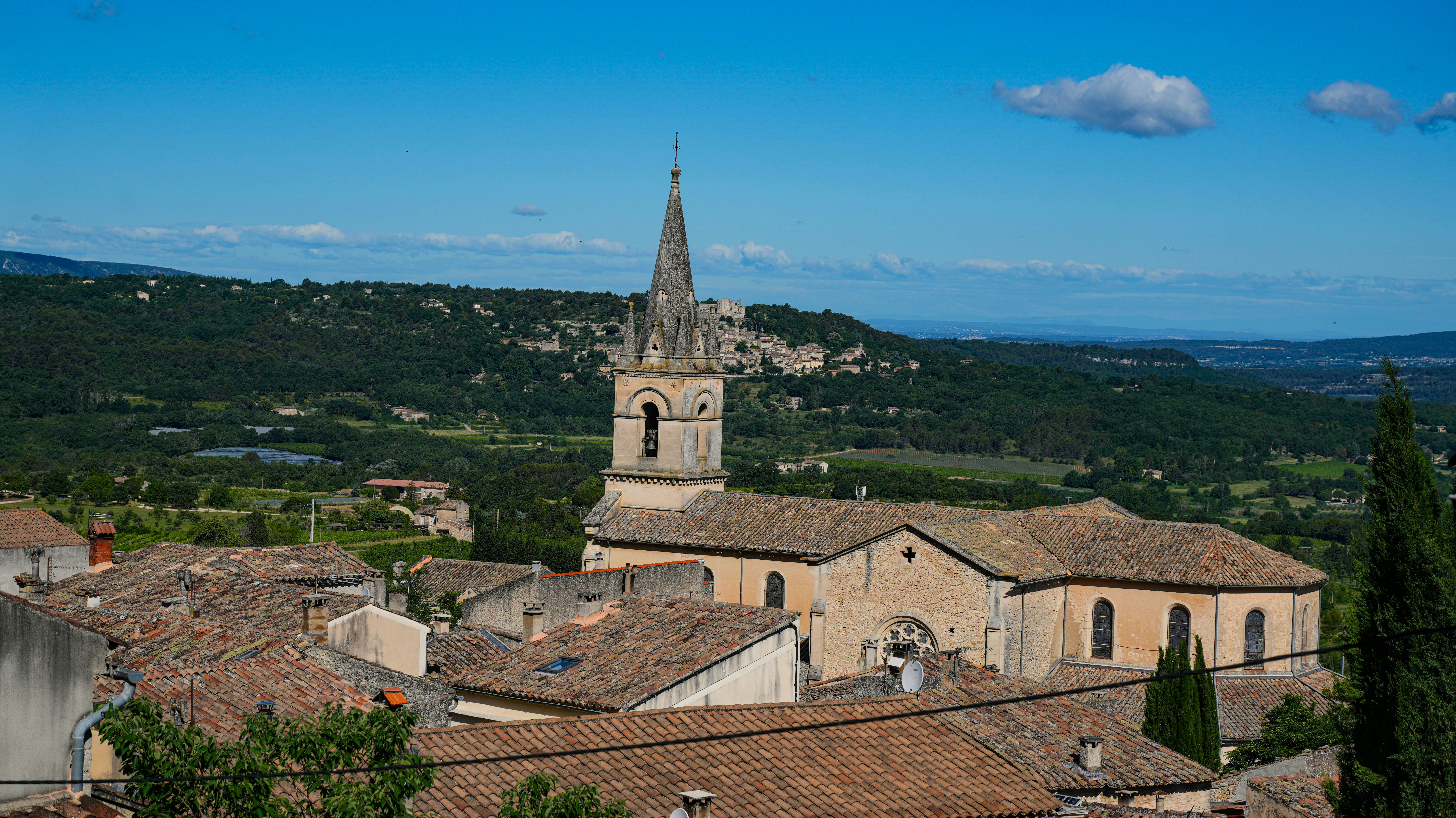 Village Bell Tower Rising Above Tile Rooftops