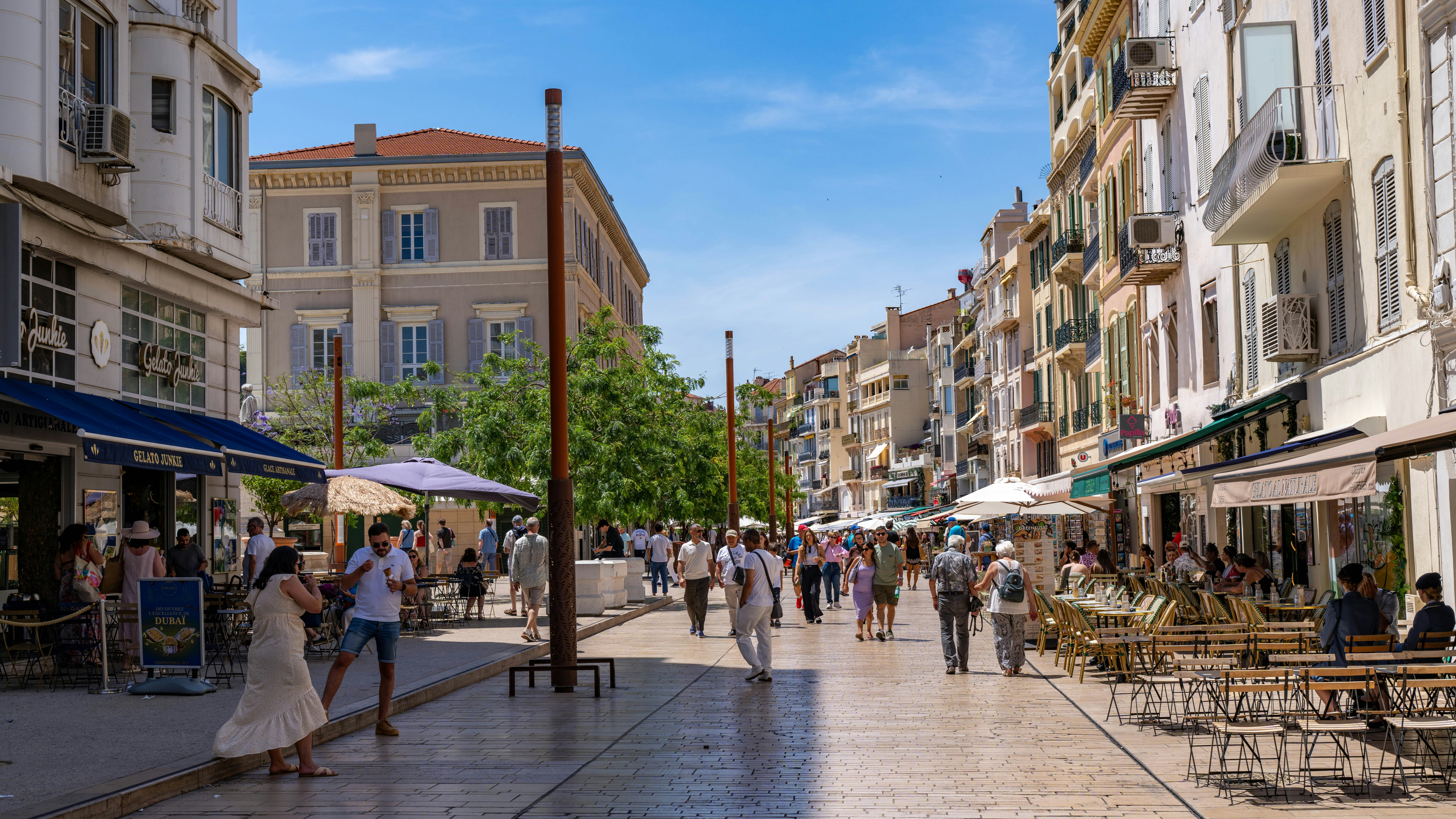 Cobbled Boulevard: A Lively Terrace Day in a Sunlit European Street