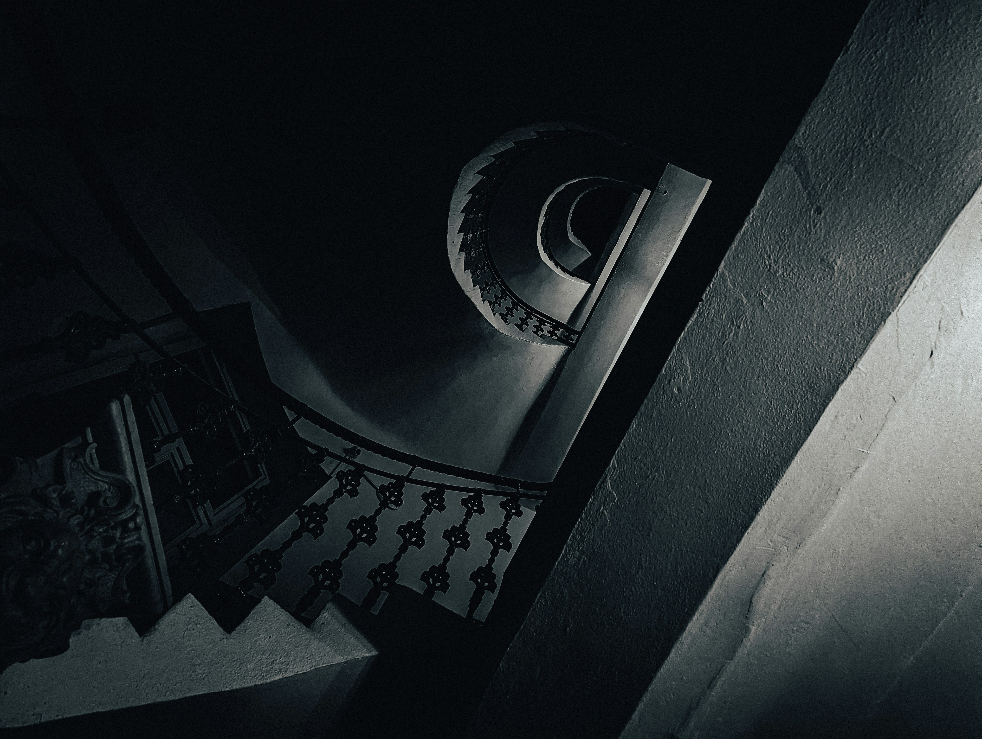 Spiral Descent: A Dim Stairwell Turns in on Itself