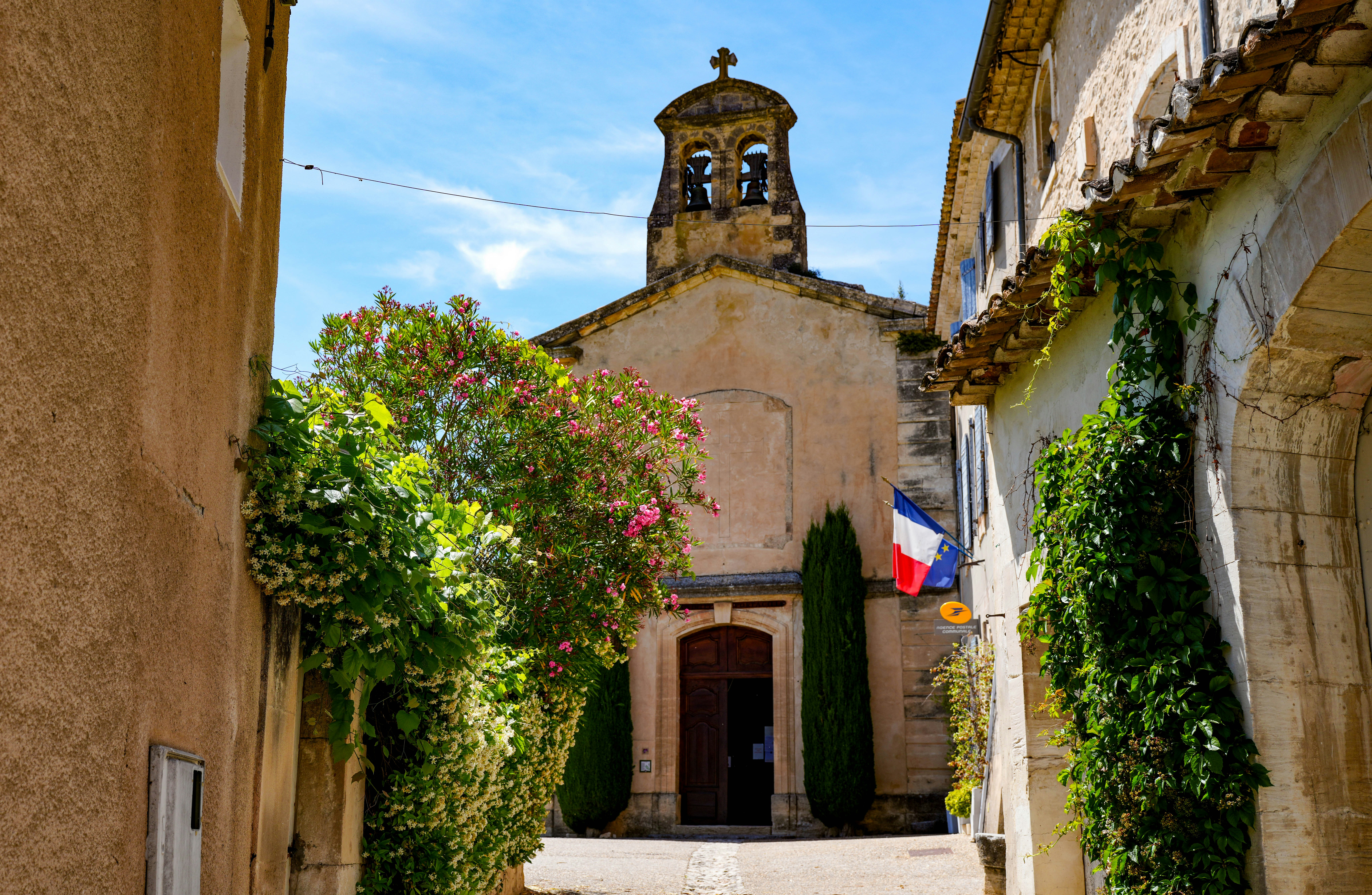 Quiet Courtyard Chapel framed by blooming greenery and a small bell tower