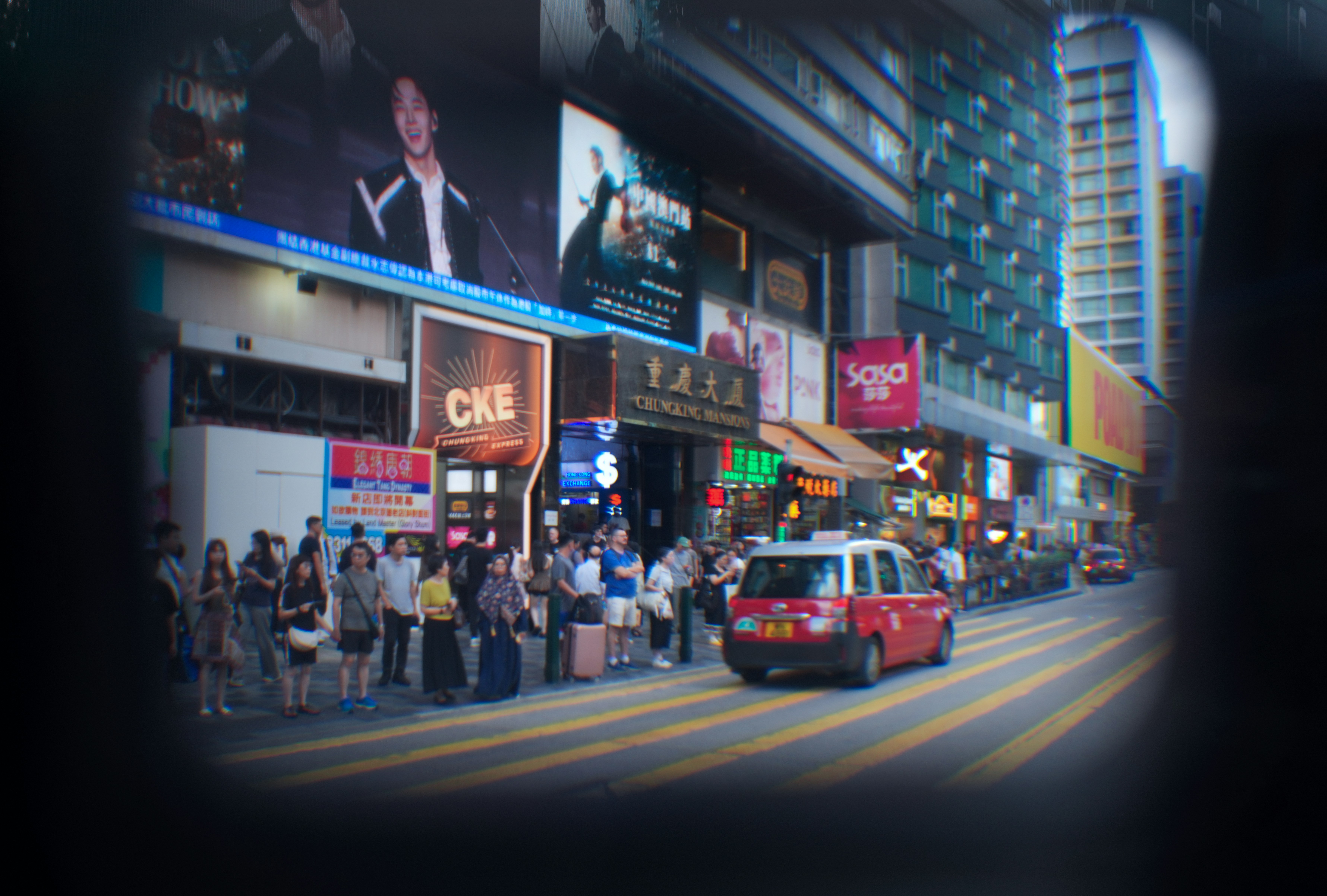 Neon City Pulse: A crowded street scene framed by storefronts and a moving taxi