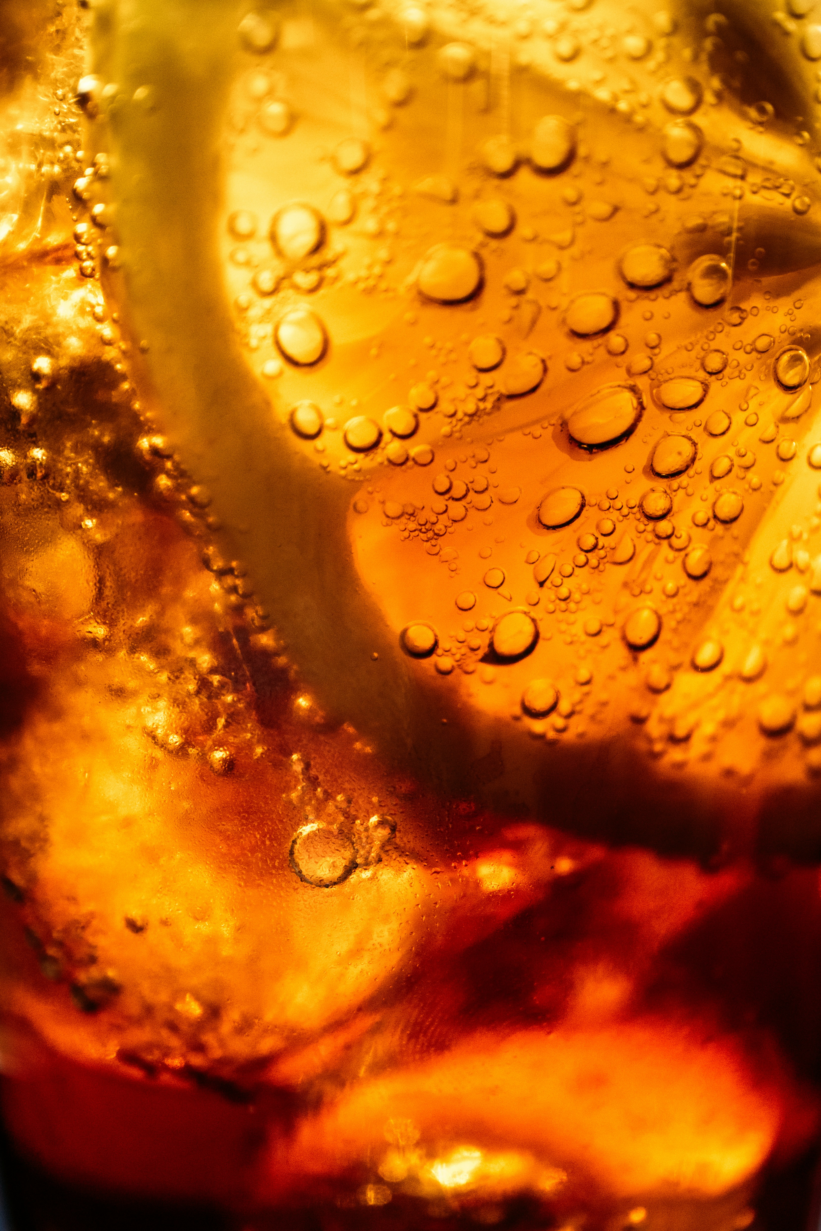 Golden Bubbles: Glowing Orbs in a Soda Burst