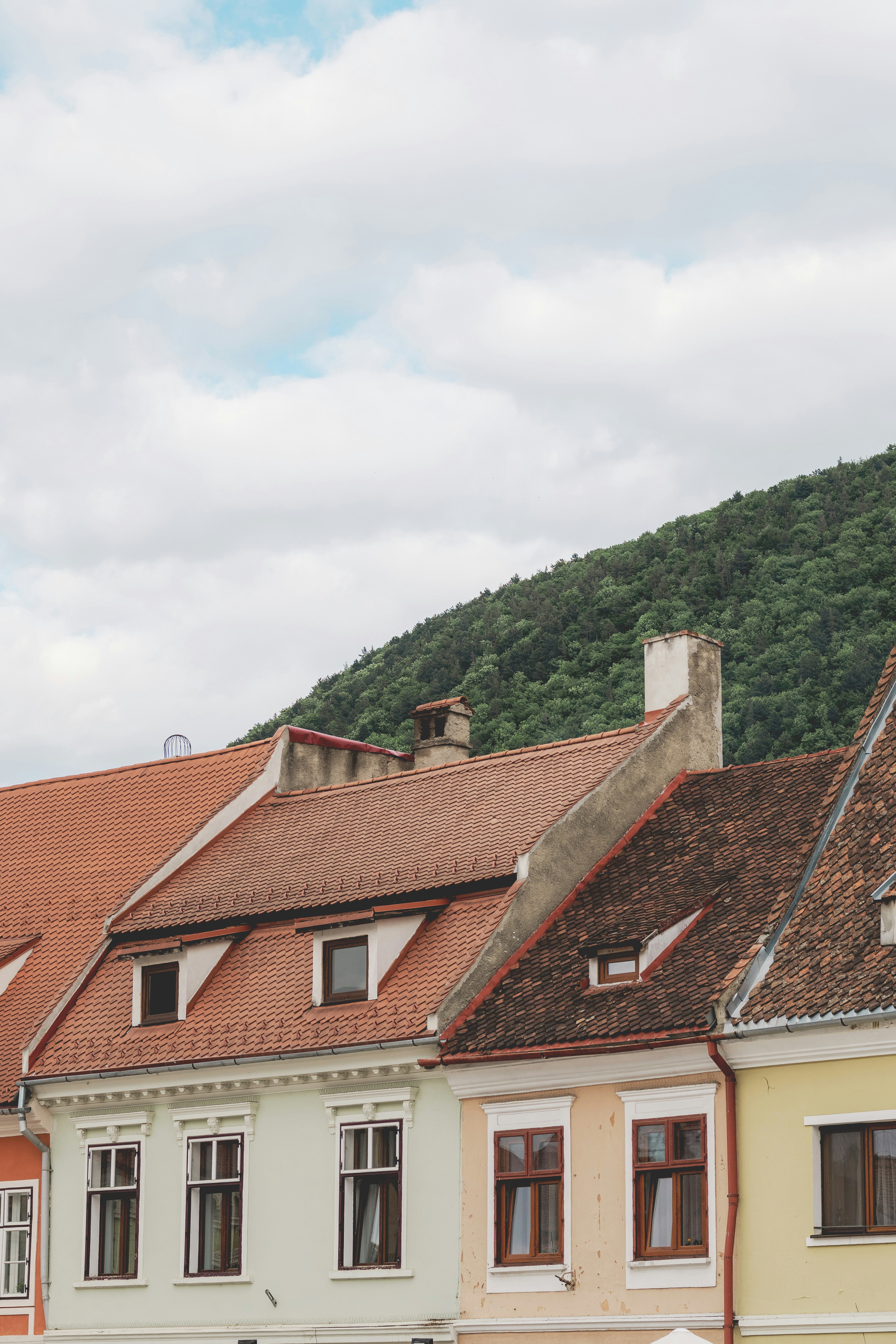 Riverside Row: A Quiet Street of Painted Facades under a Cloudy Sky
