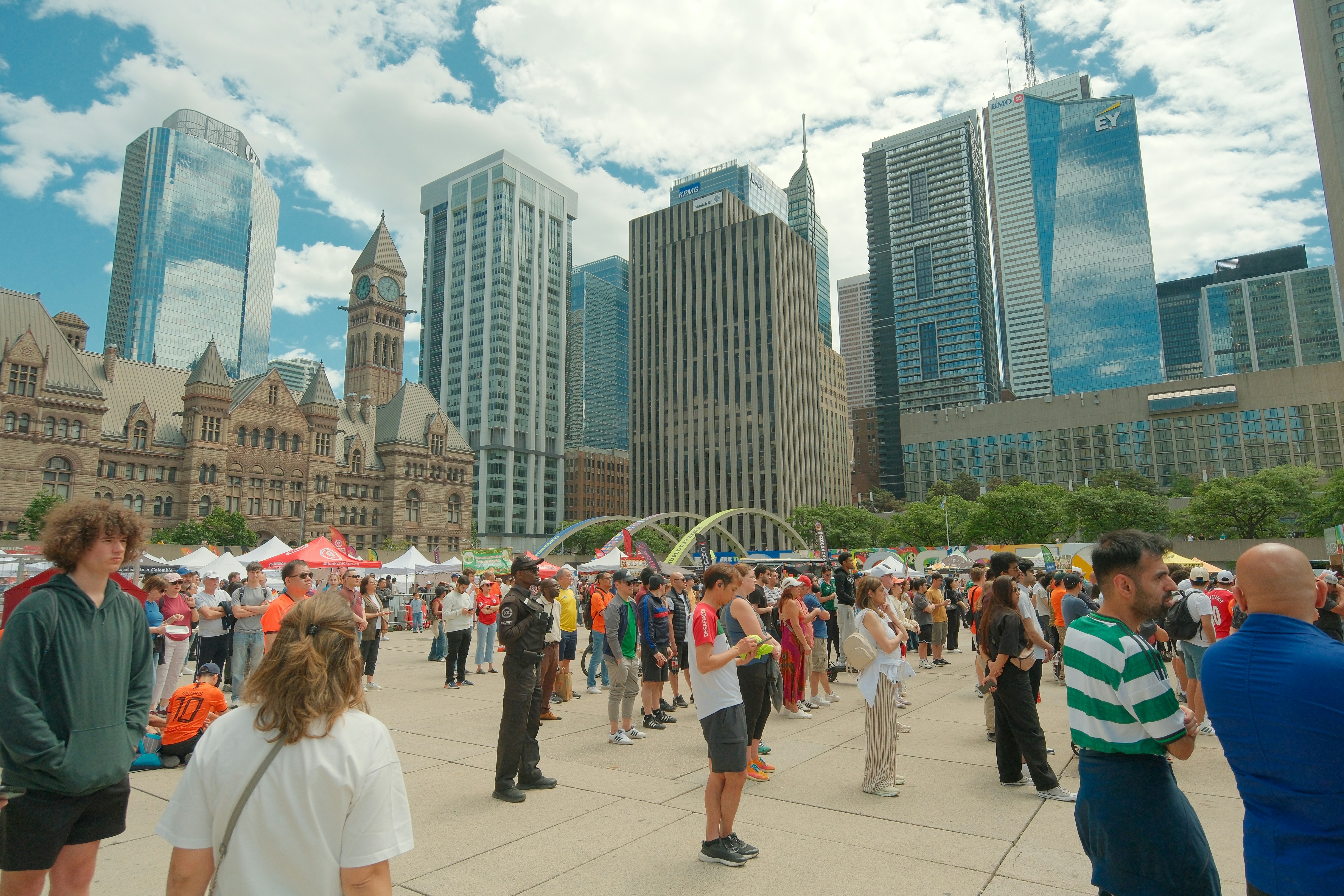 City Crowd Under Towering Skyscrapers at Crowd-Driven Plaza