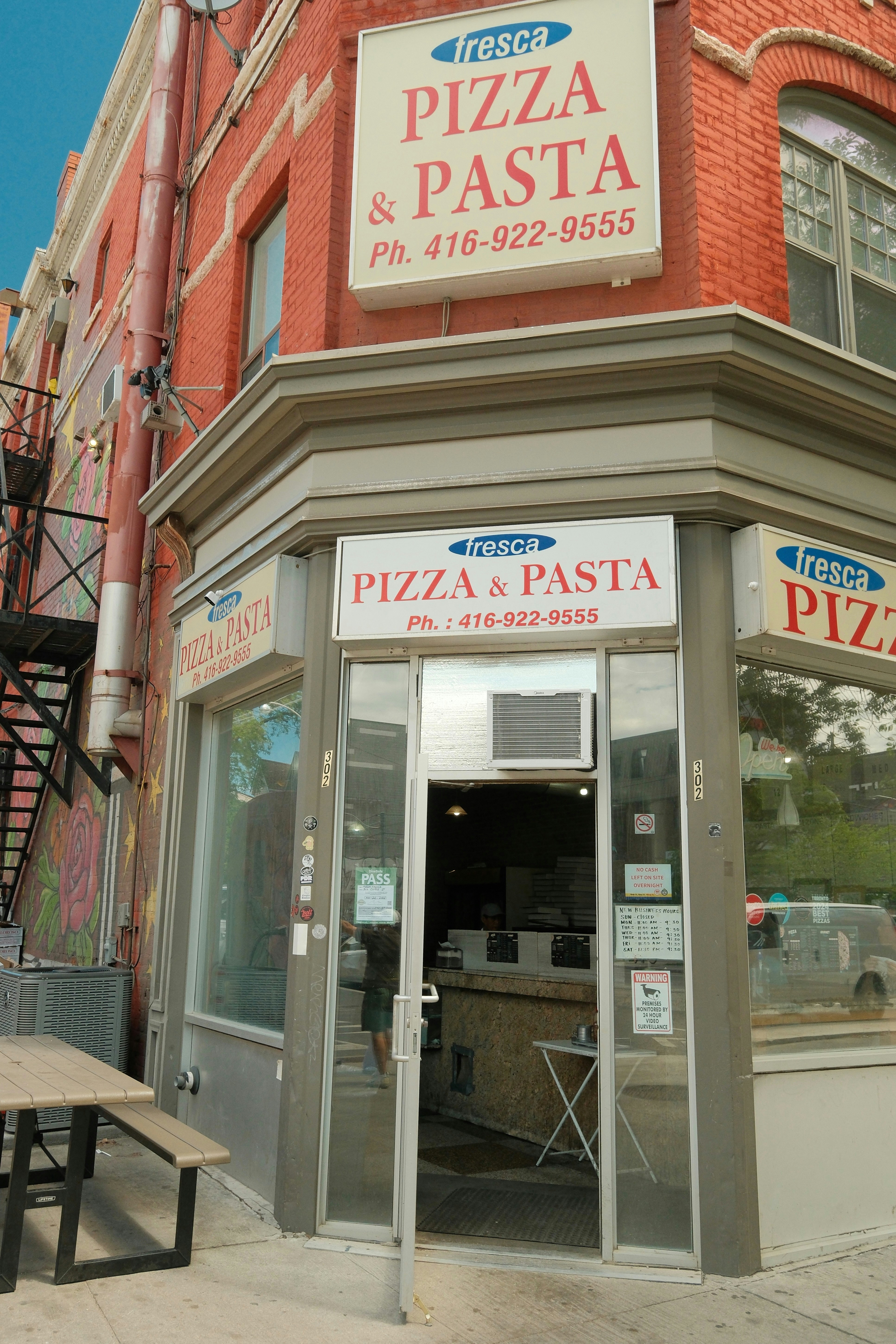 Pizza Signage on a Red Brick Corner Café