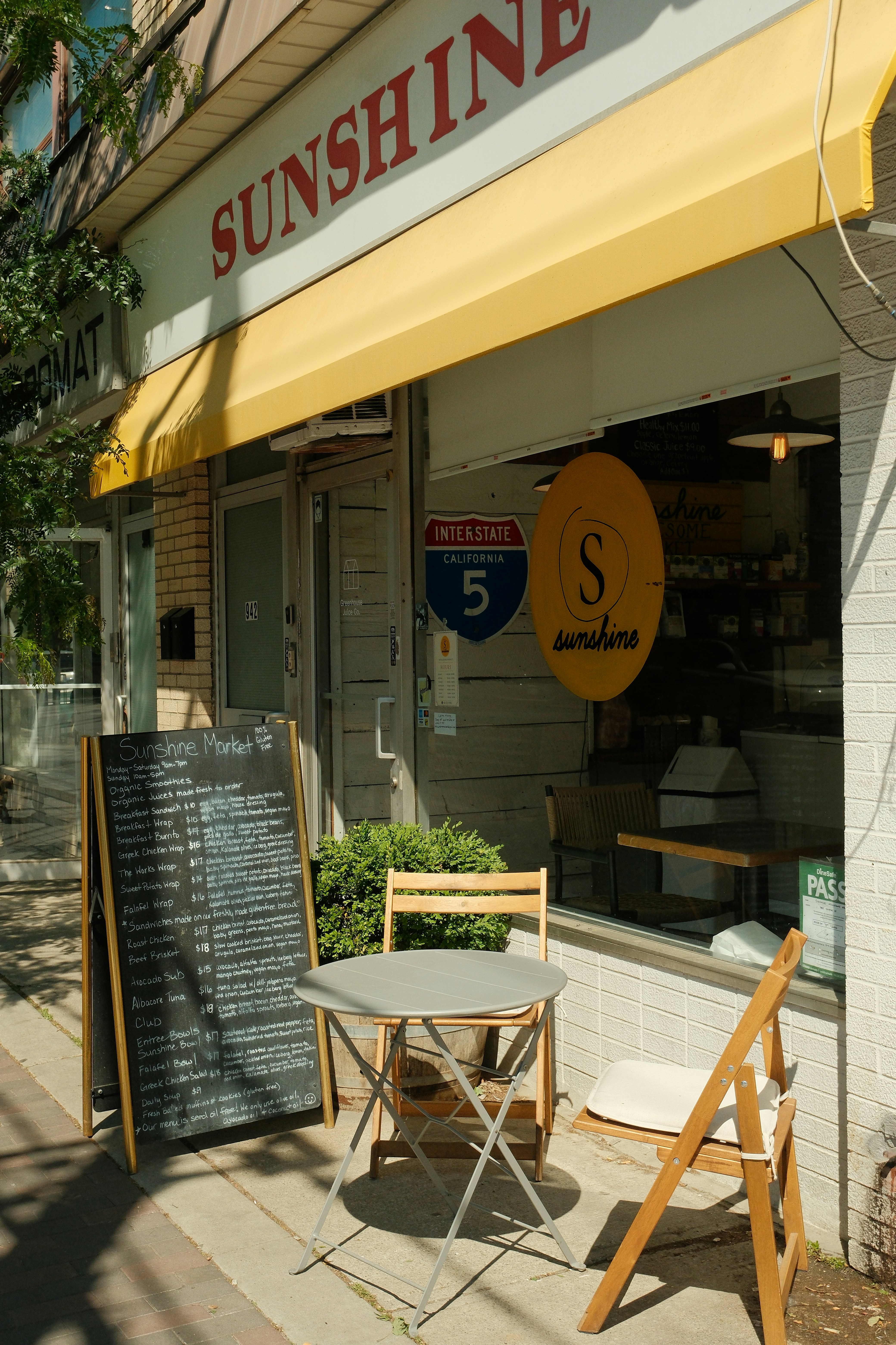 Sunshine Café Terrace: Sunny Street View of a Corner Market