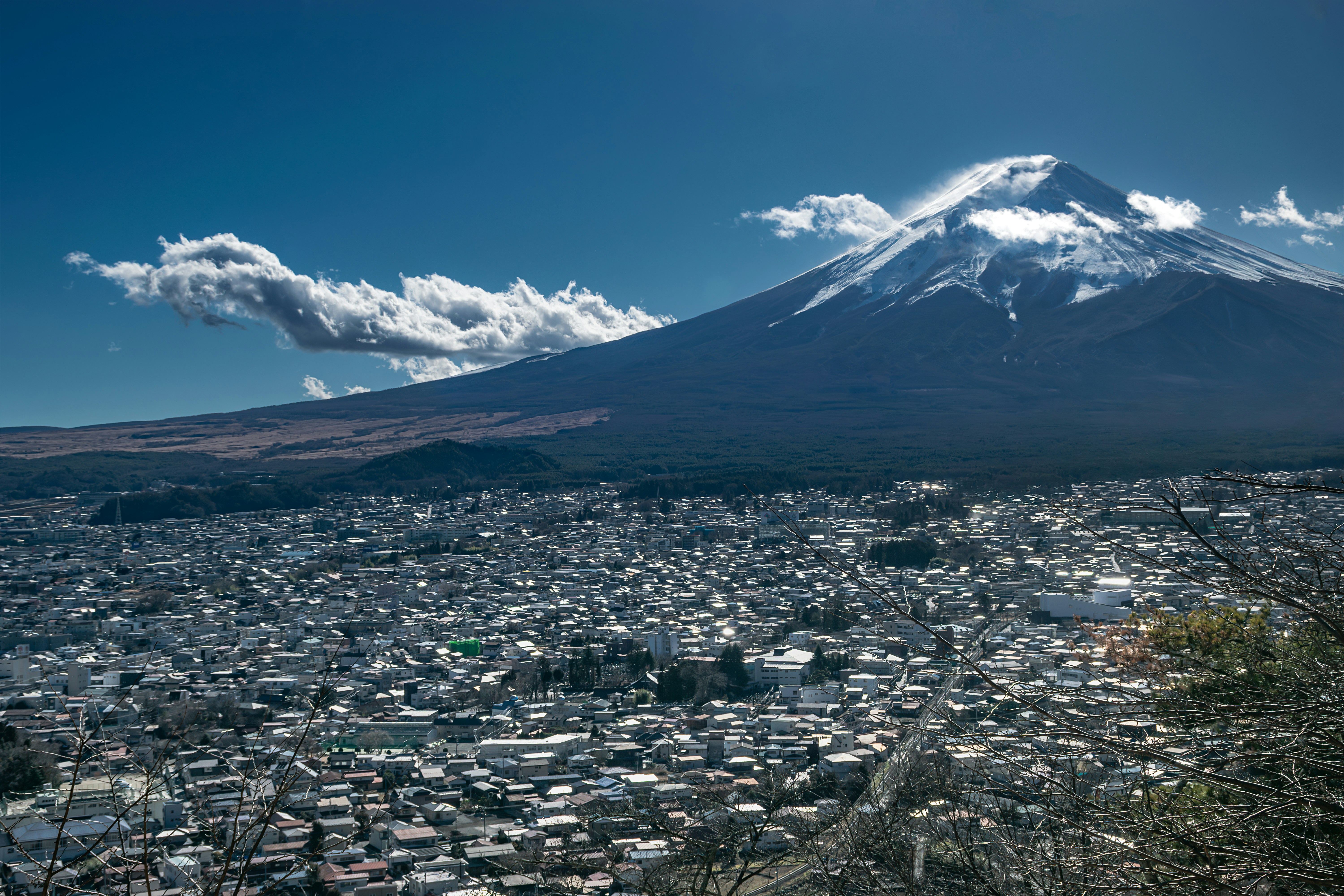 Fuji-like Volcanic Summit Over a Dotted Townscape