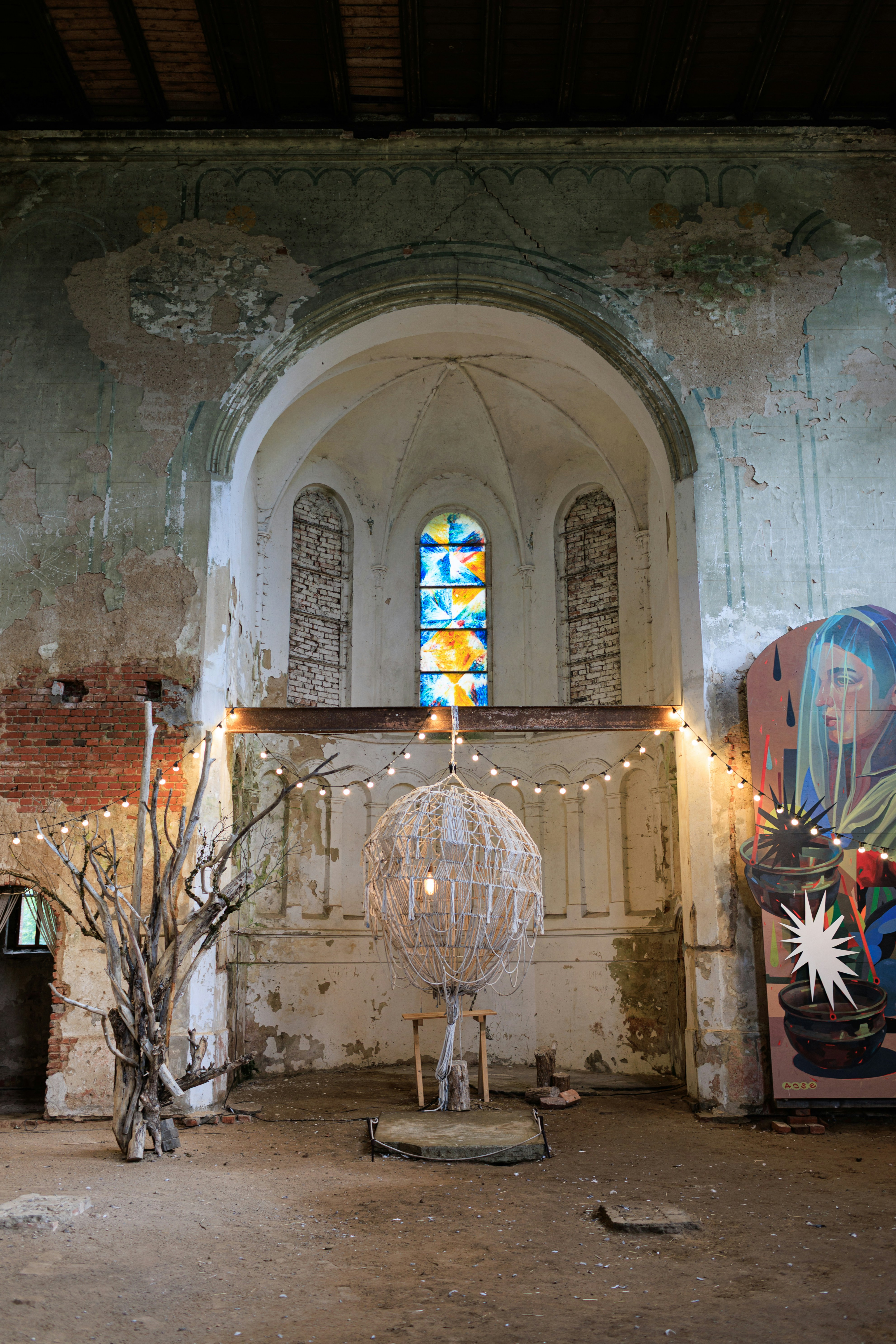 Stained Glass Light: A Sacred Centerpiece in a Worn Hall