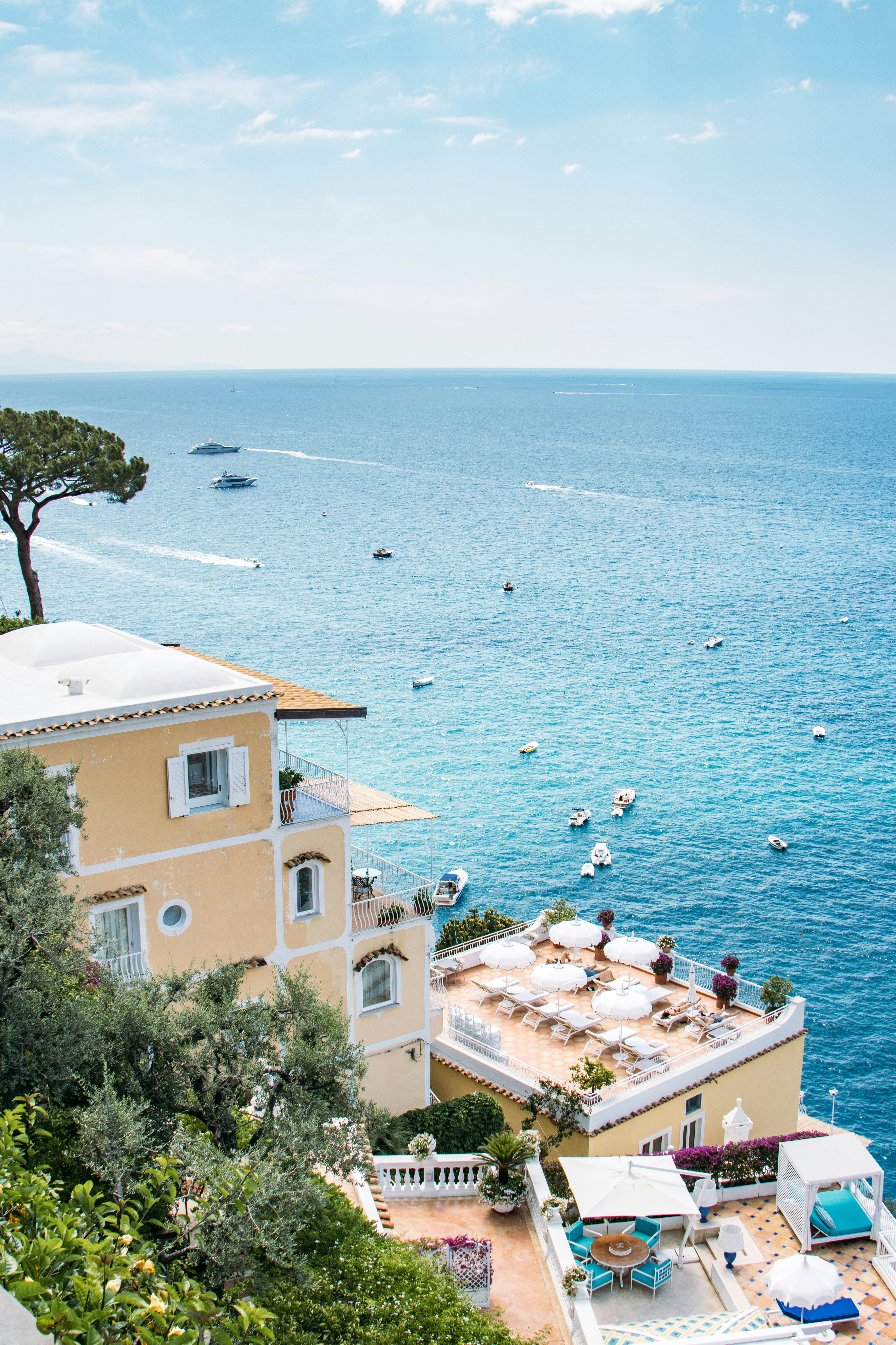 Terraced seaside villa with aqua Mediterranean backdrop