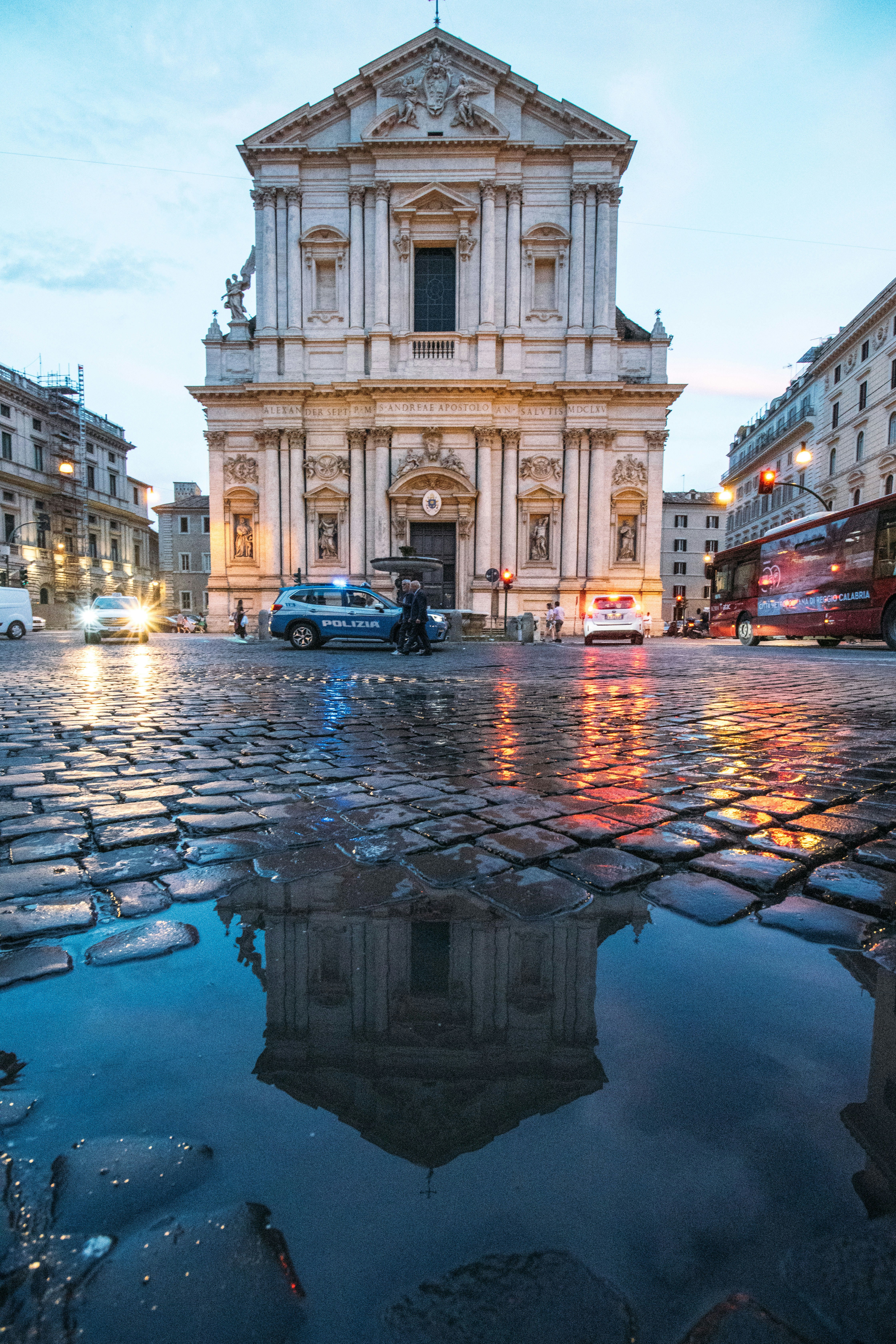 Reflection of a grand Baroque facade in rain-washed cobbles
