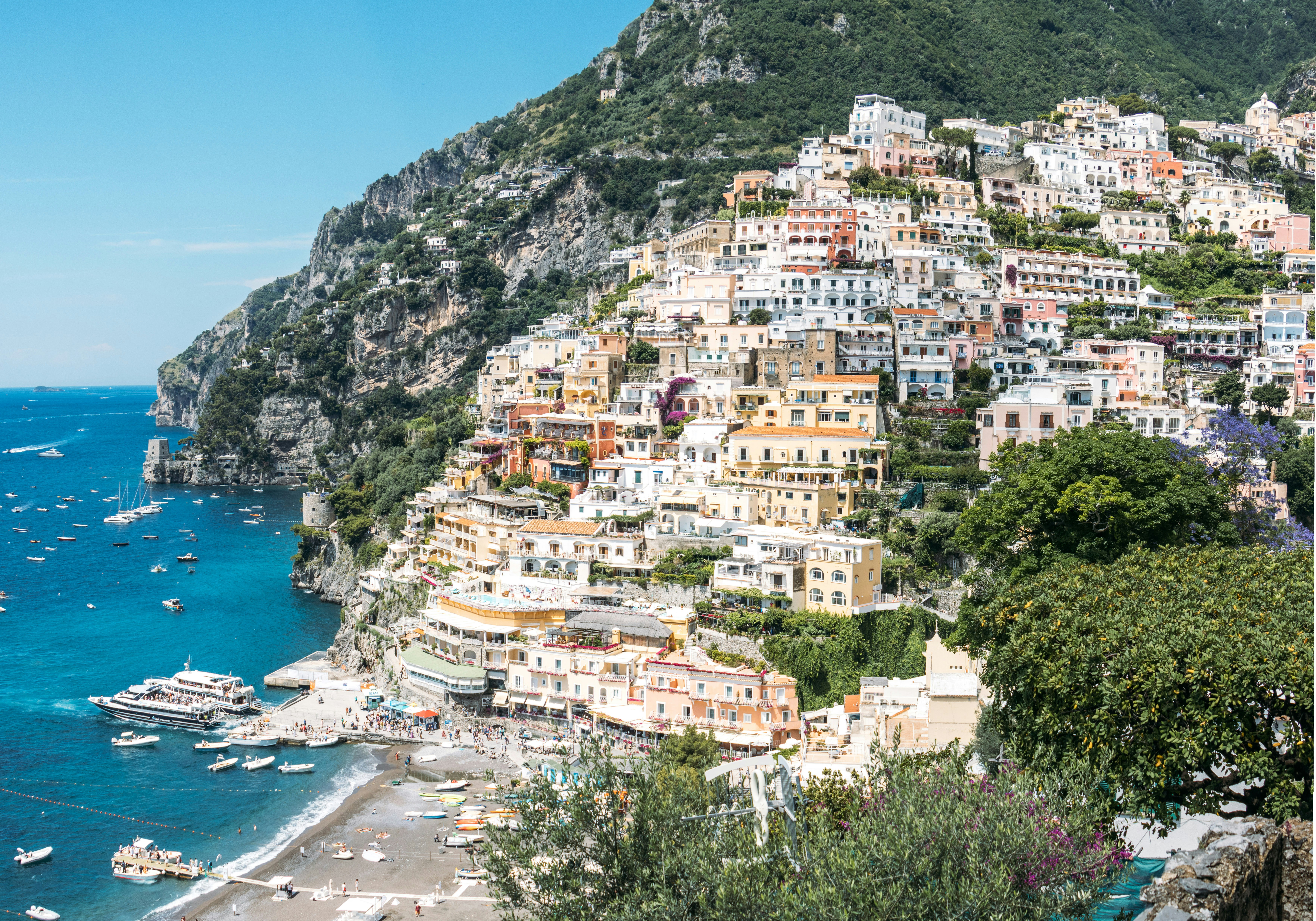 Colorful hillside town spilling into a cobalt sea