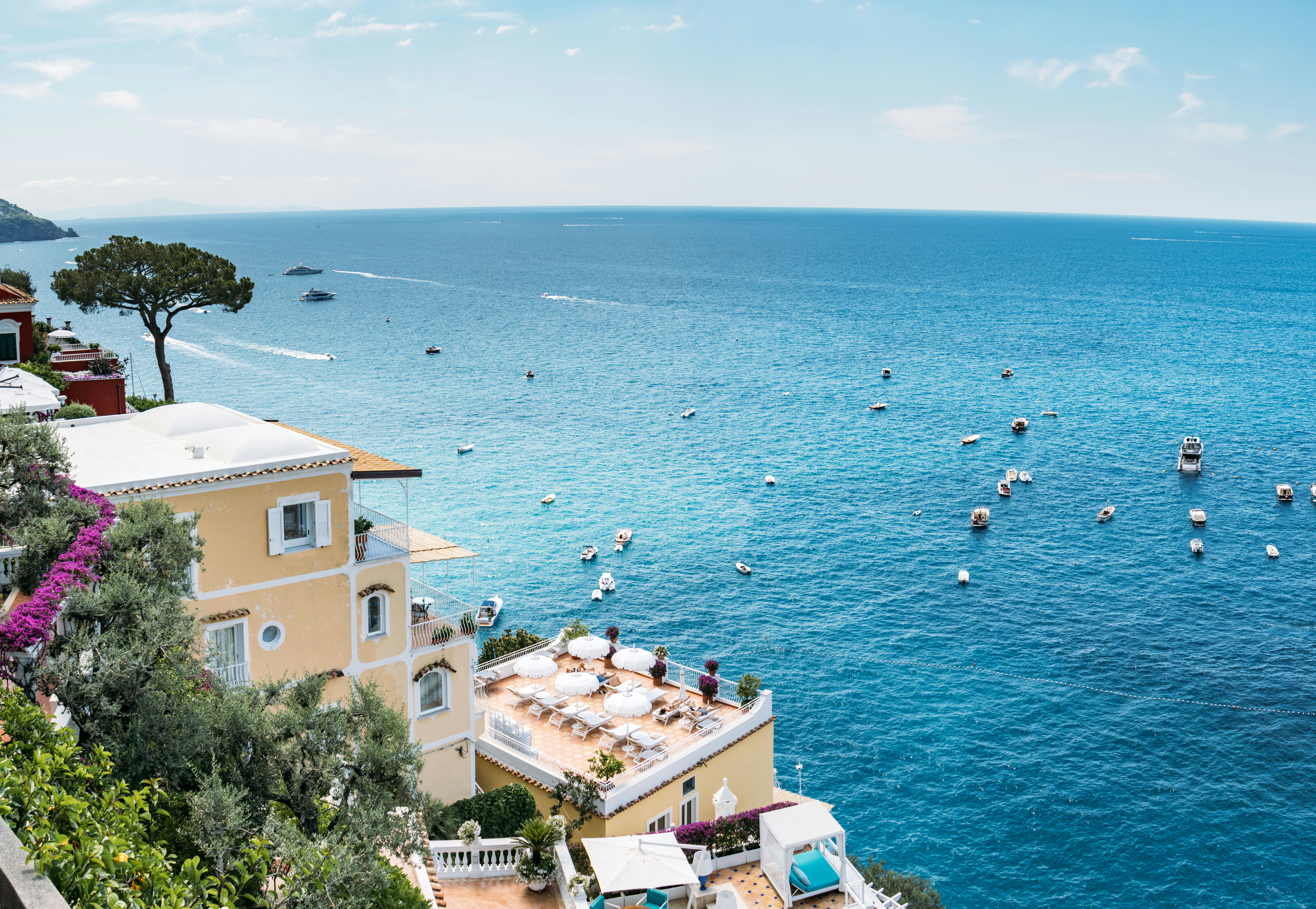 Terraced villas by a turquoise Mediterranean shoreline