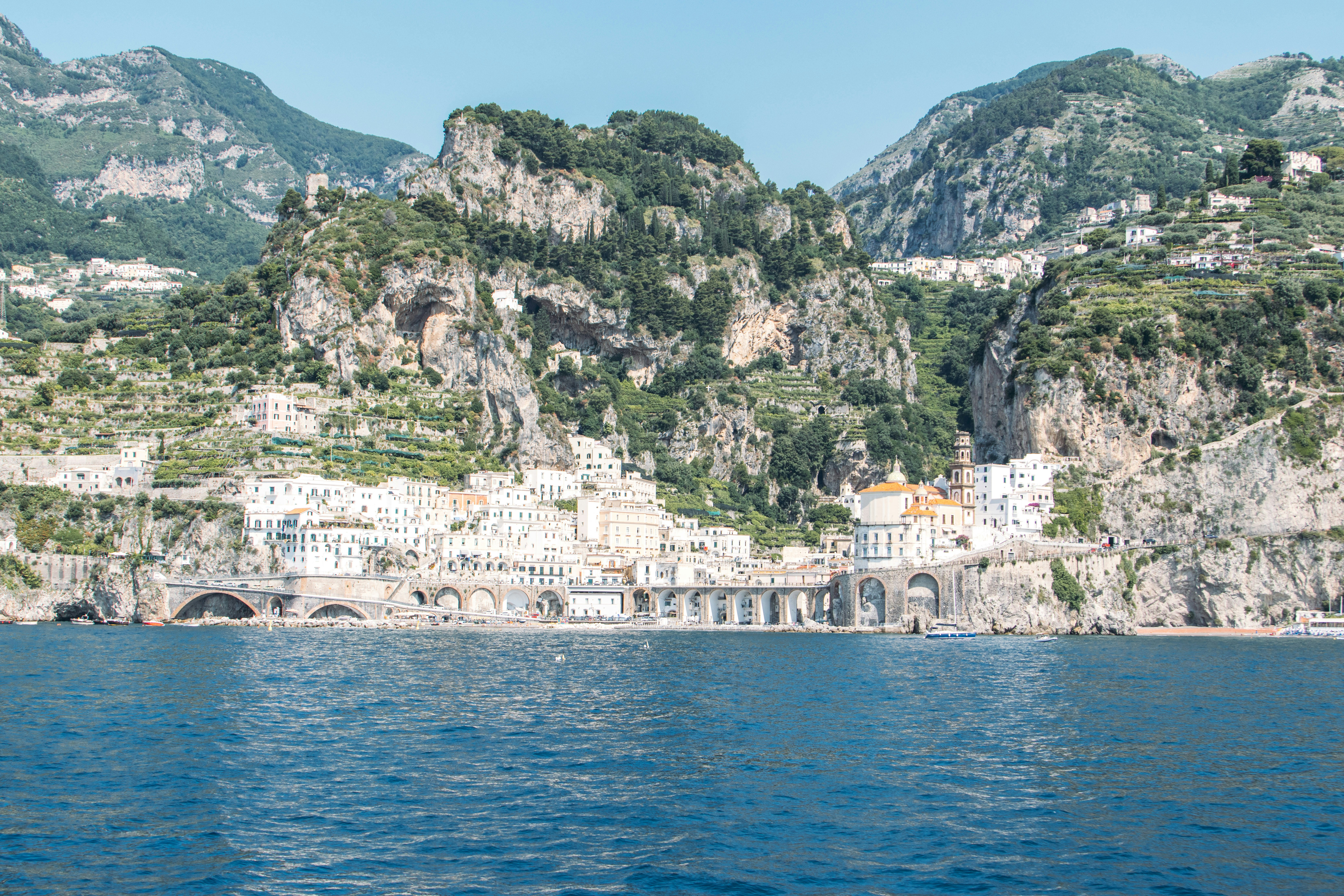 Limestone Coastal Village Embraced by Sea and Cliffs