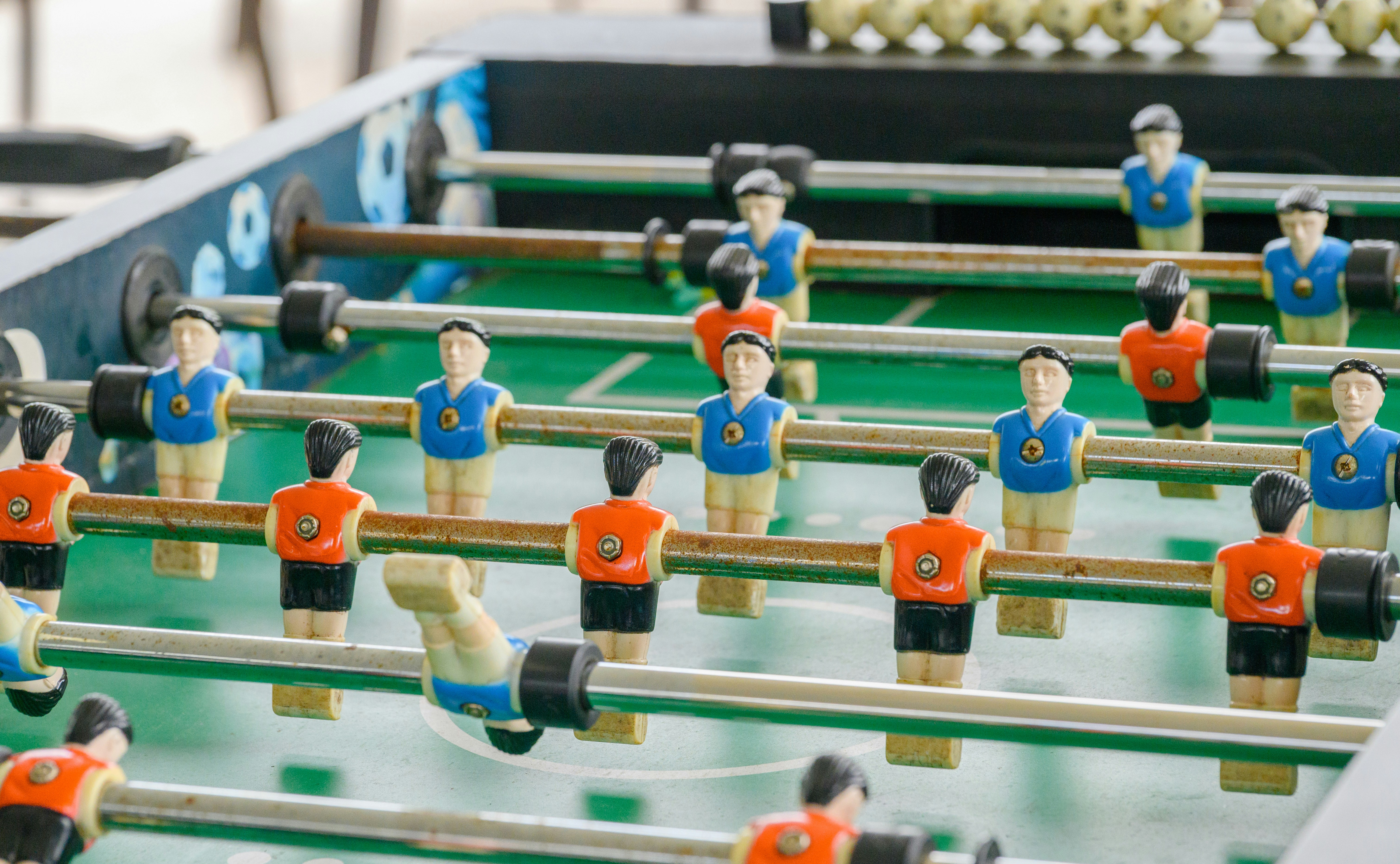 Miniature Foosball World: A Field of Tiny Players on Green Neatness