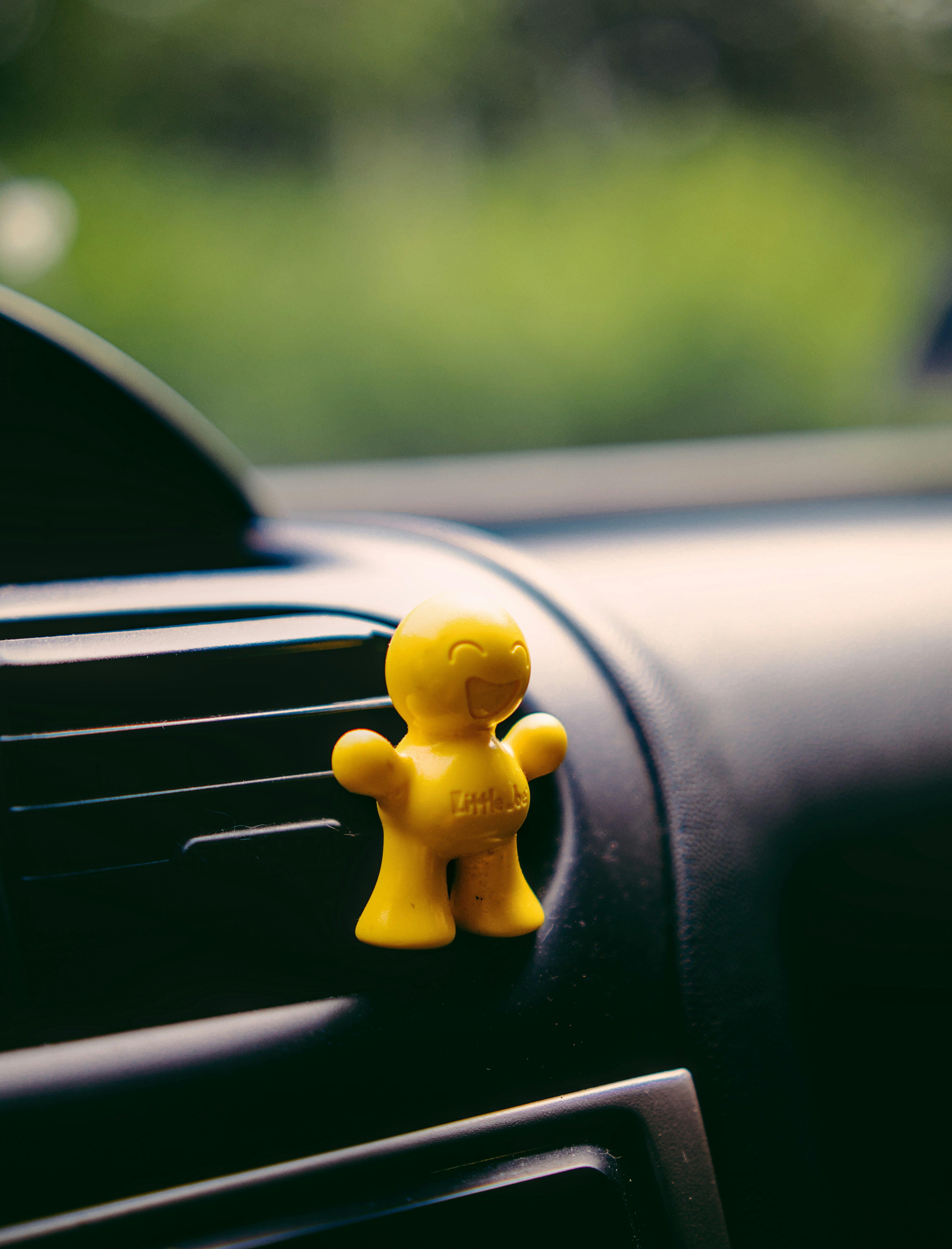 Yellow Gumdrop on the Car Dashboard: A Tiny Sentinel
