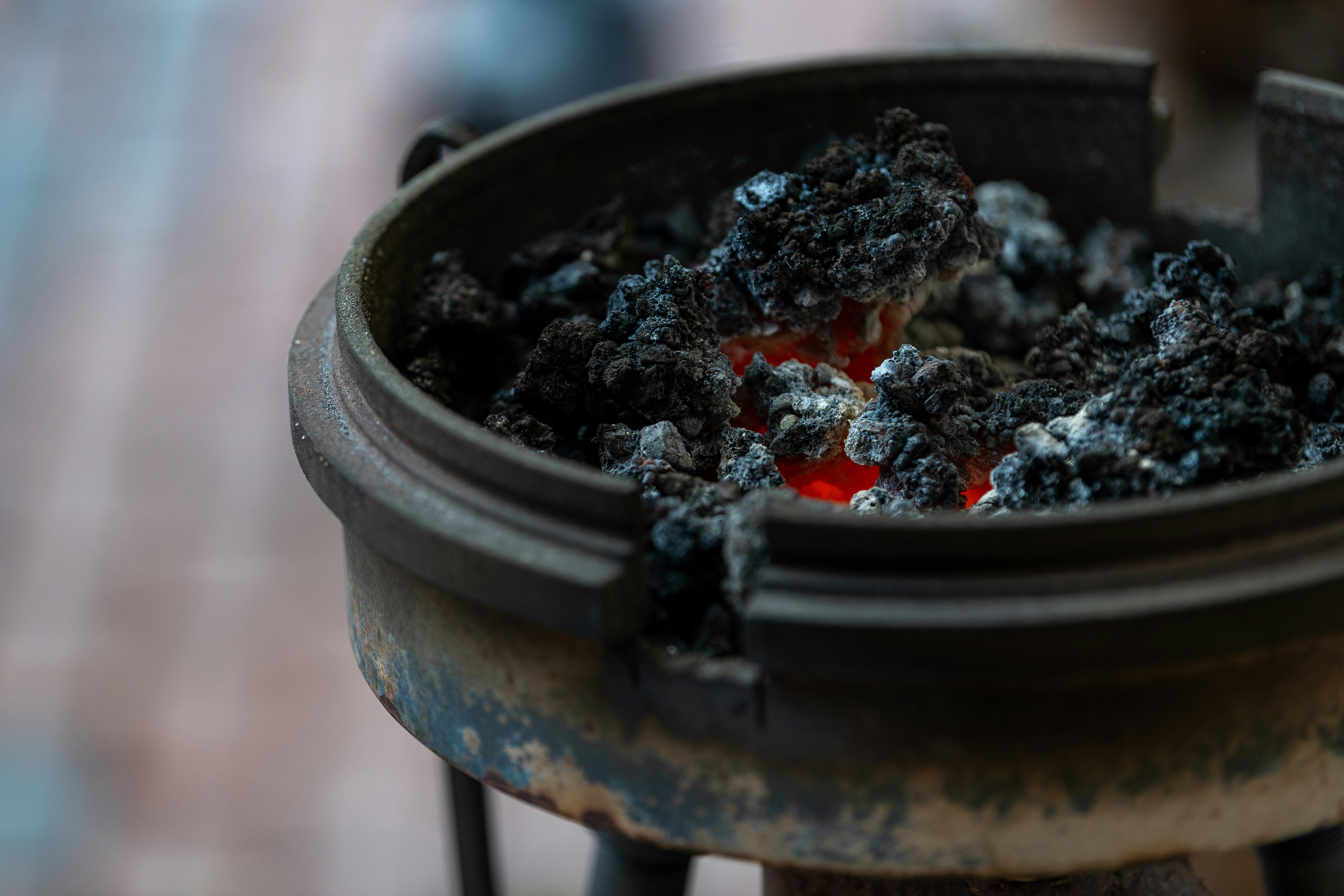 Embers of Quiet Heat: Charcoal Still Glowing in a rustic brazier