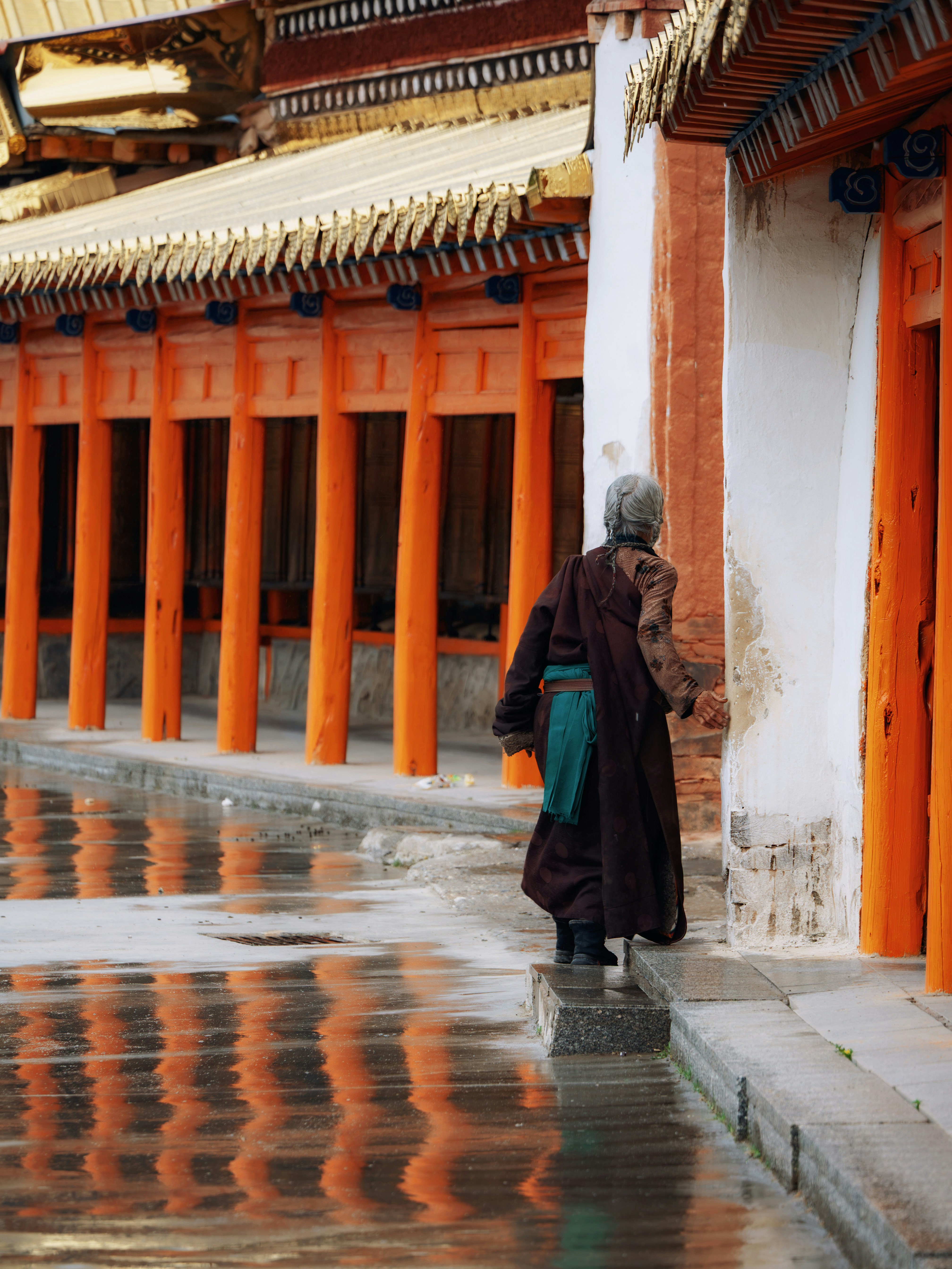 Traveler in a Corridor of Lantern-Colored Columns