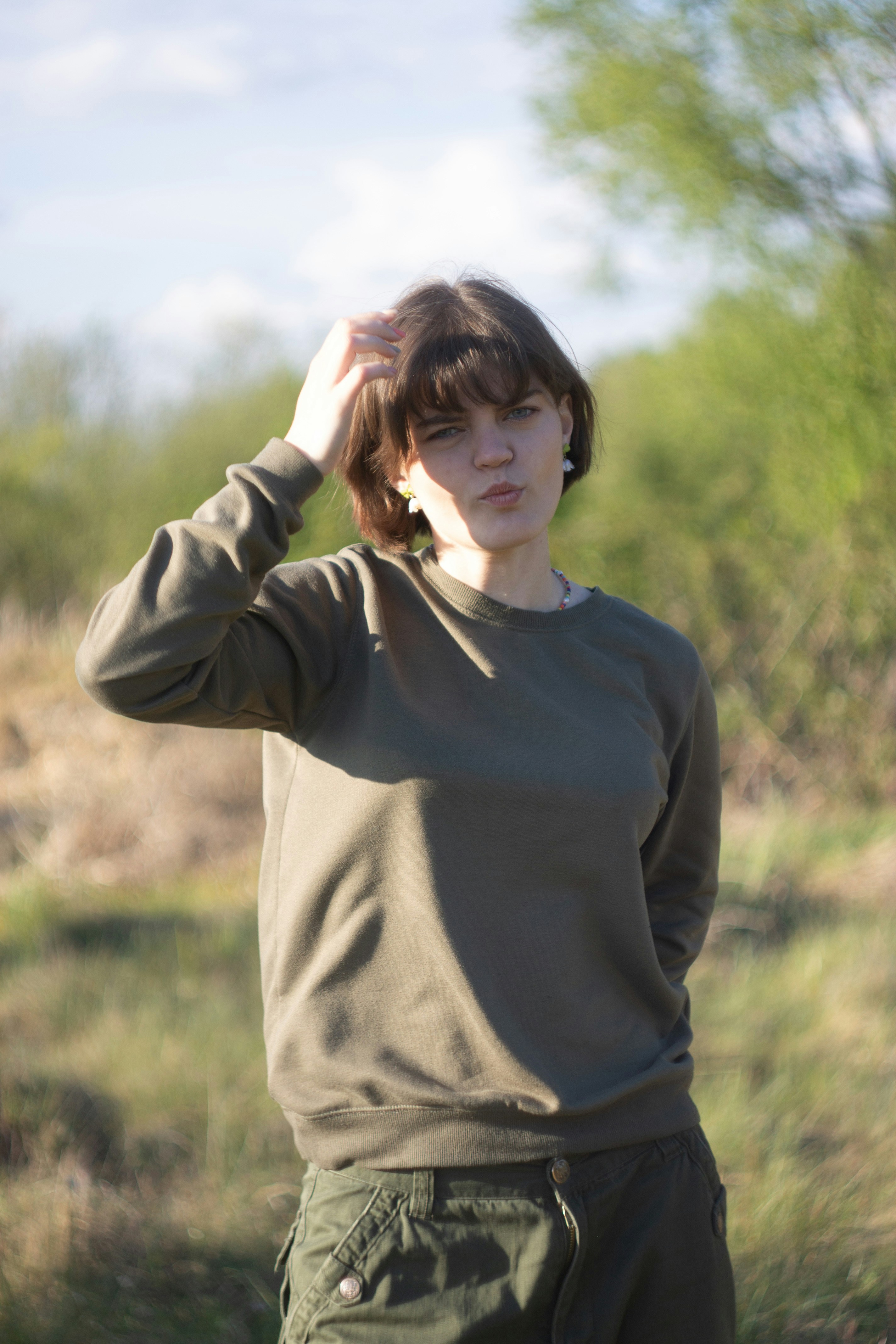 Soft Portrait in Sunlit Field with contemplative stance