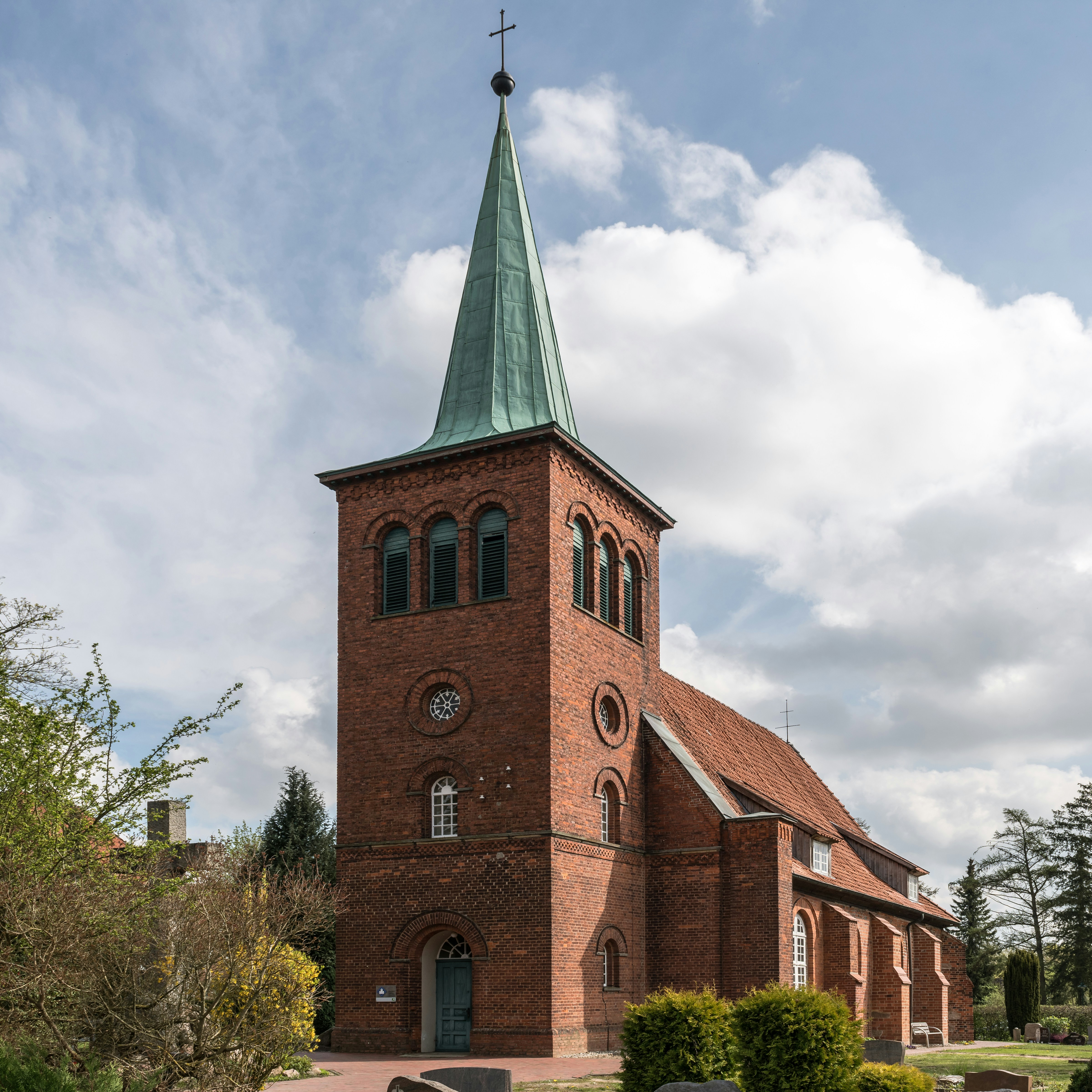 Brick Bell Tower Rising Above a Quiet Churchyard