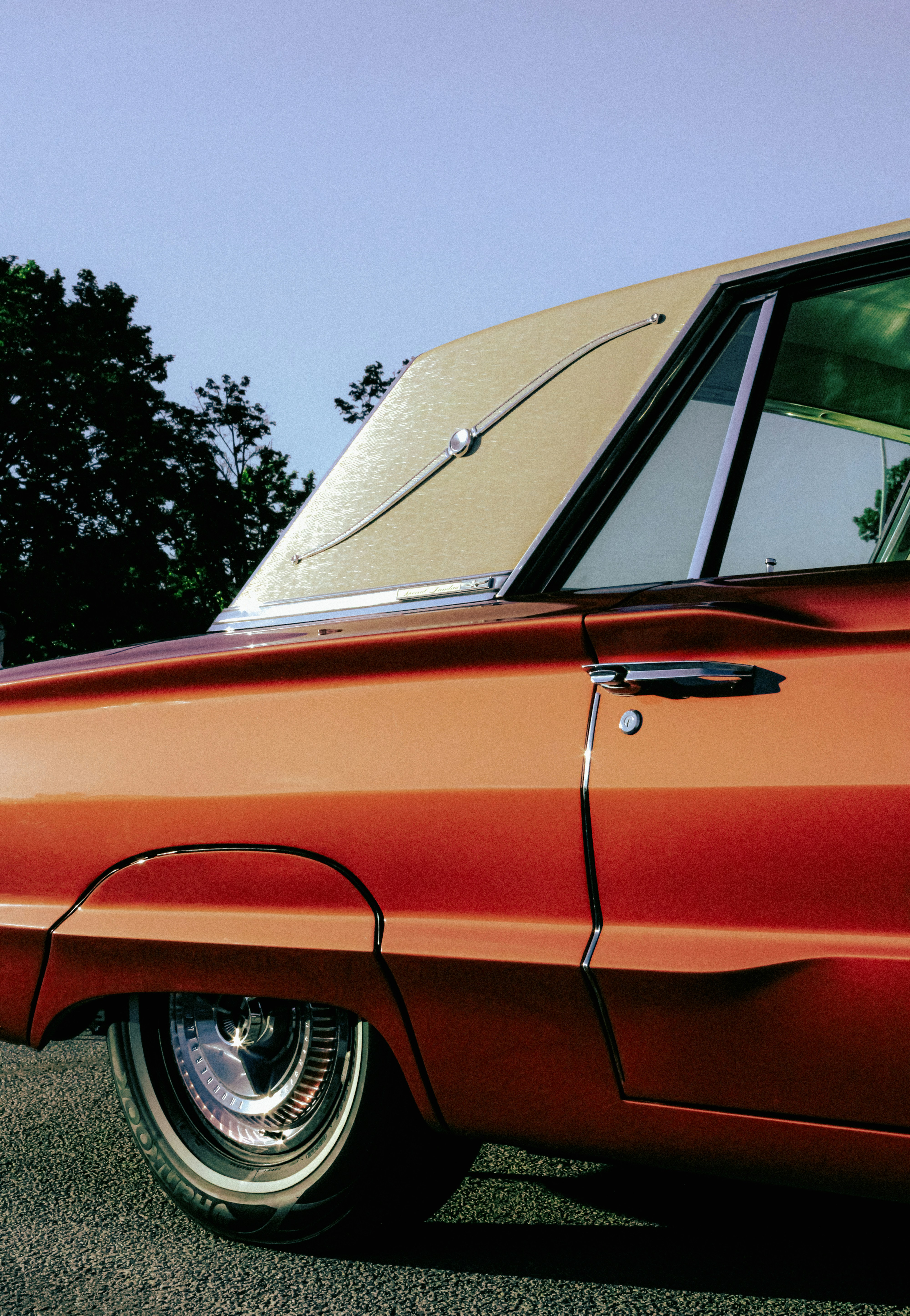 Chromed Horizon: A Close-Shot of a Sunset-Red Classic Car