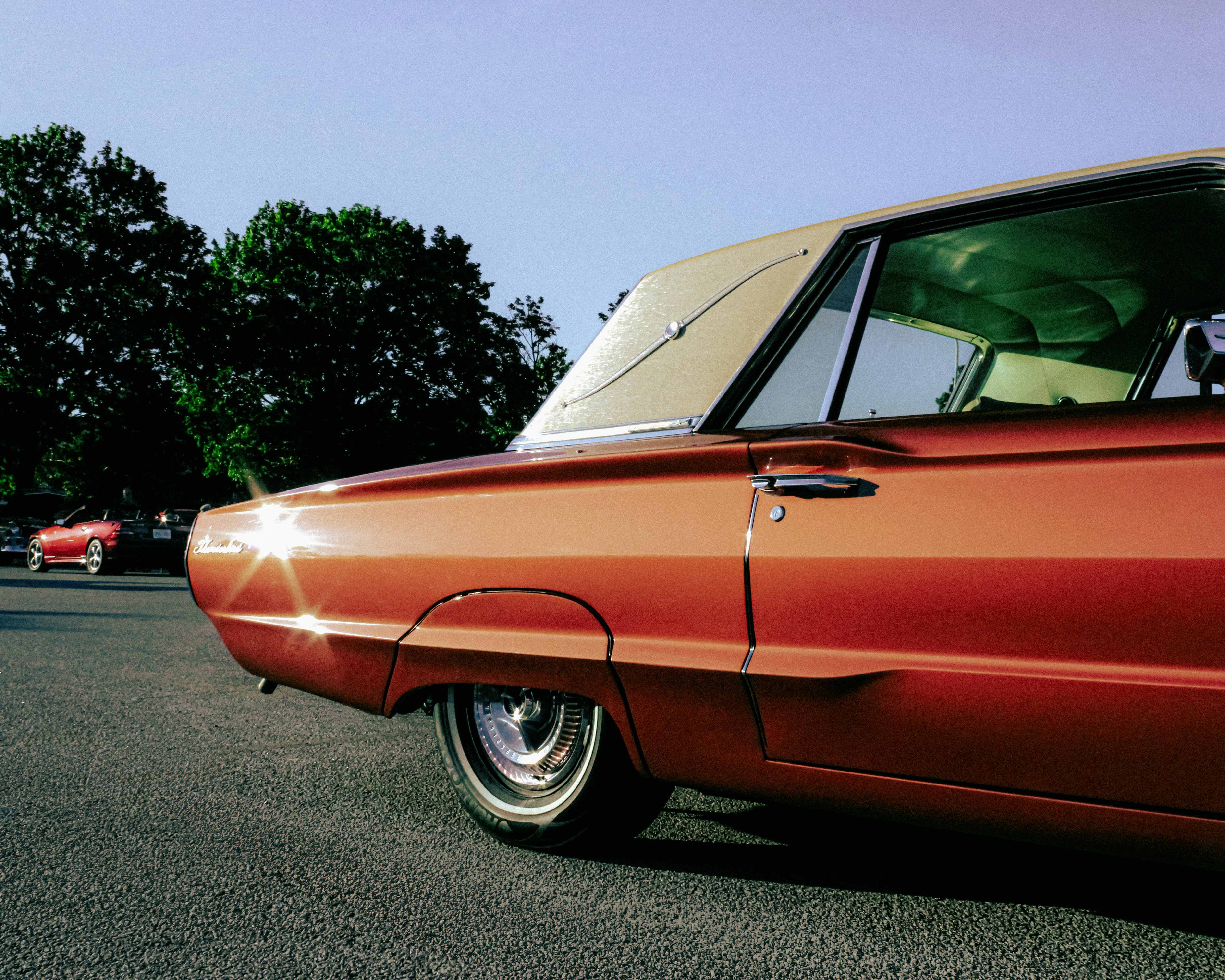 Low-Angle Glint: A Glorious Orange Classic at Dusk-Lite Parking Lot