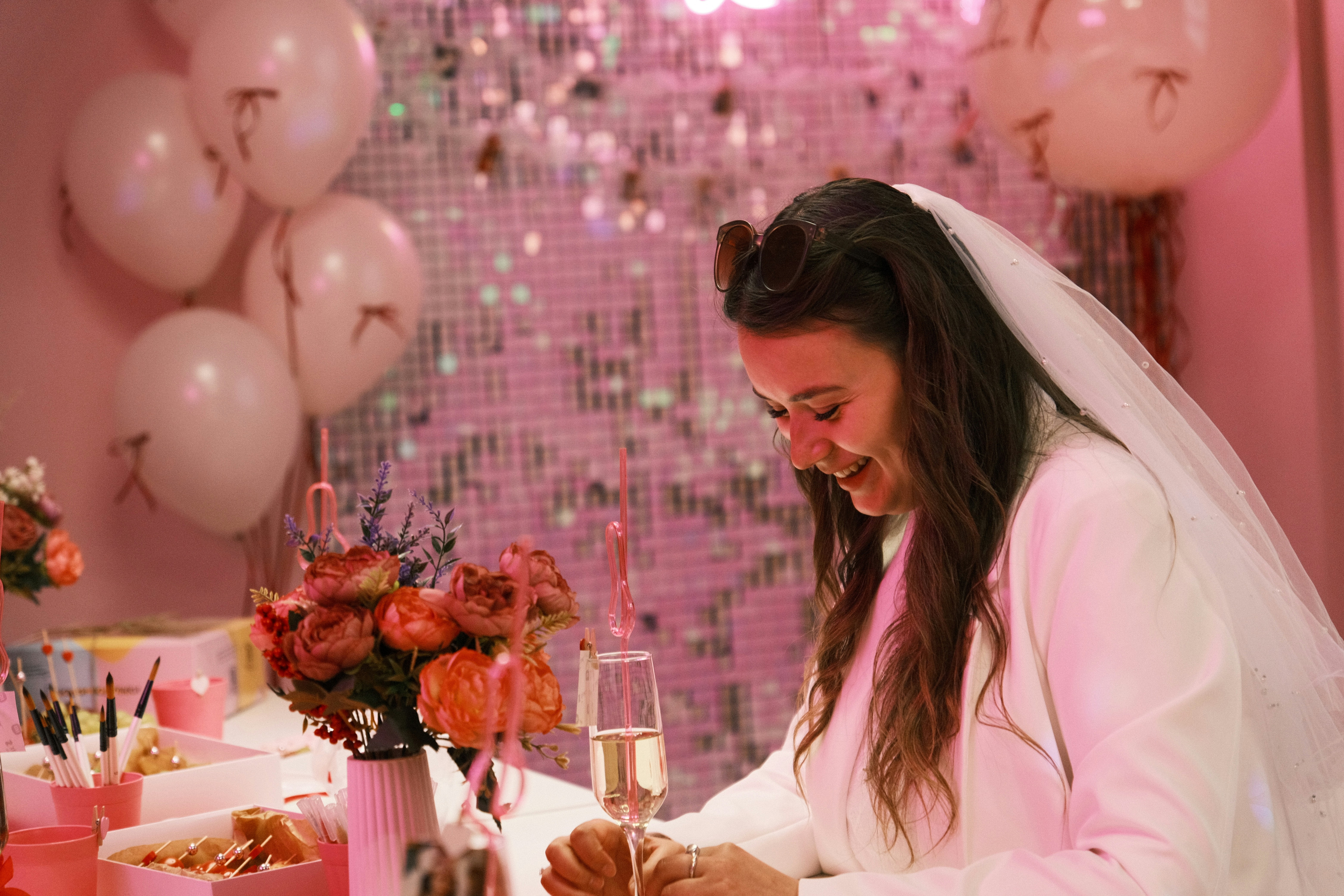 Bride in a blush-lit celebration: a candid moment at the table